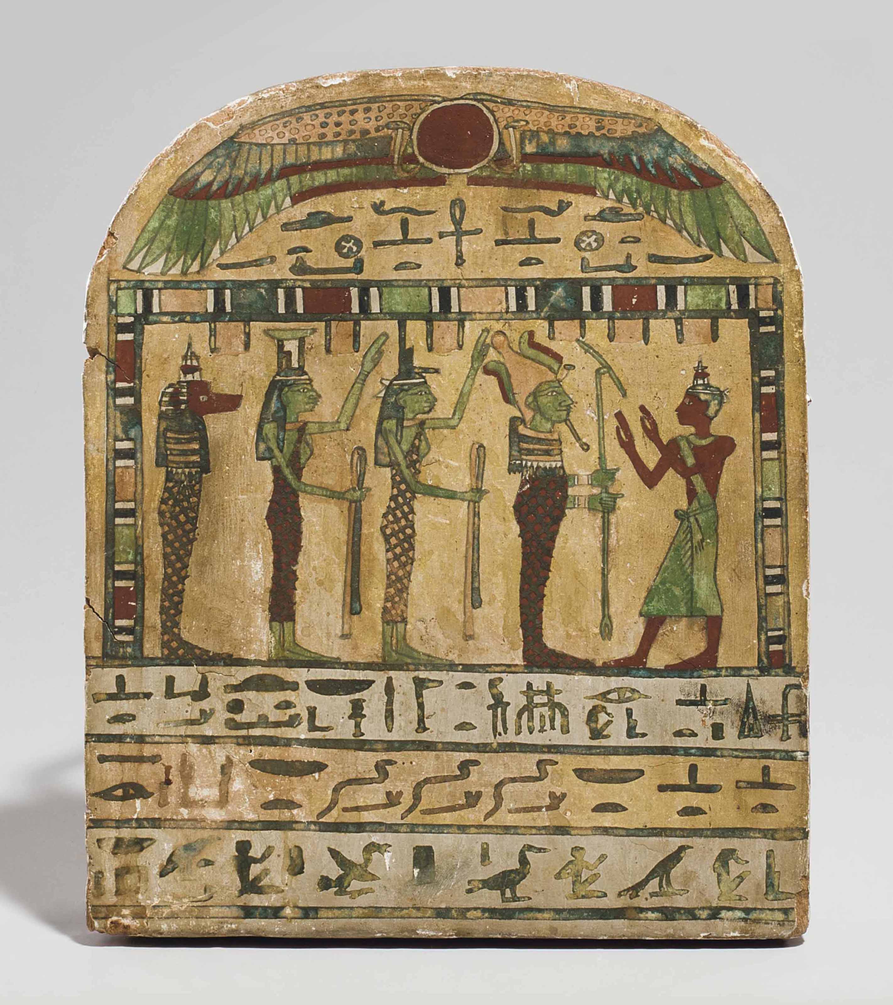 AN EGYPTIAN PAINTED WOOD ROUND-TOPPED STELE FOR HOR , EARLY PTOLEMAIC ...