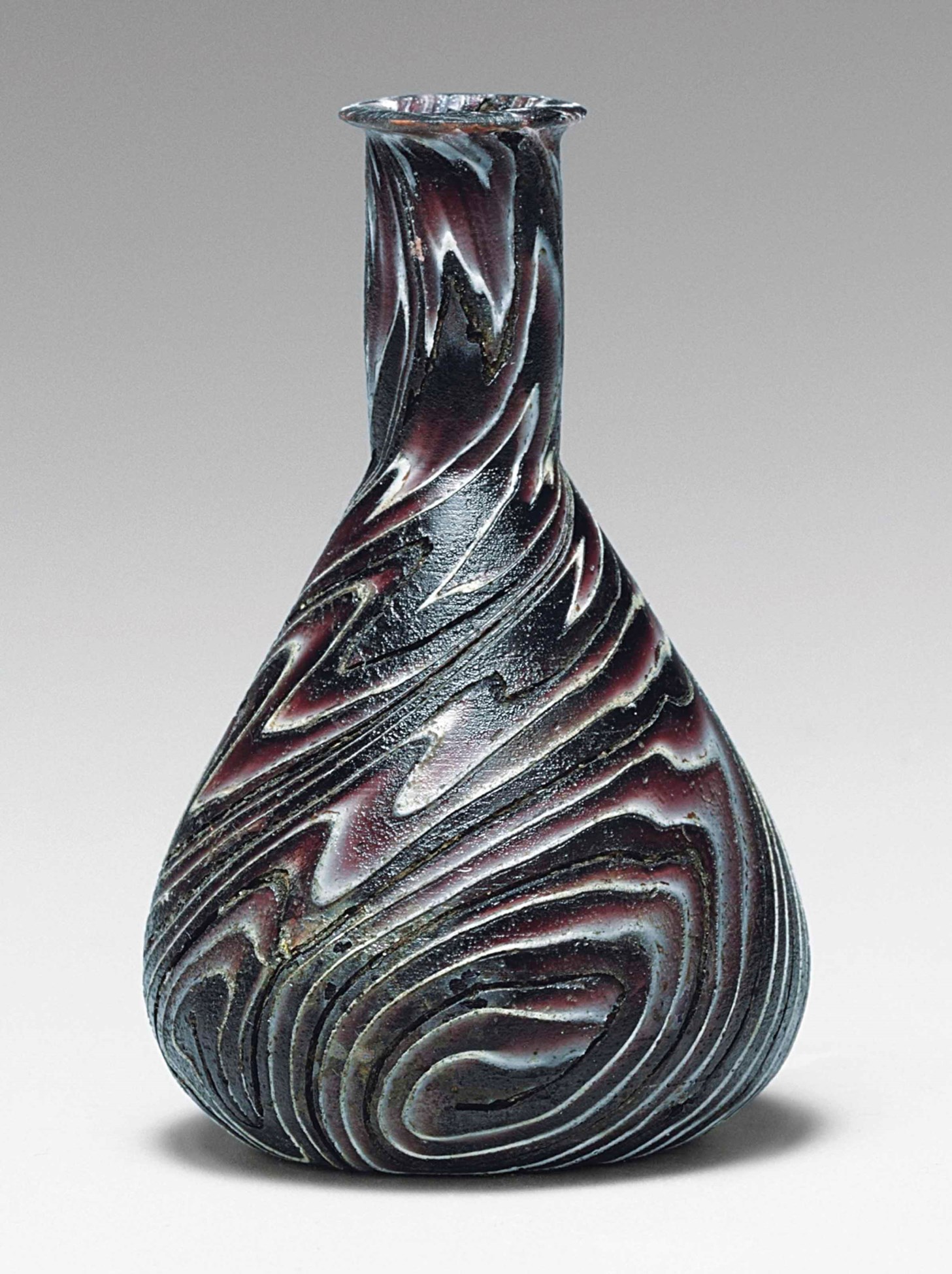 A ROMAN RIBBON GLASS BOTTLE , CIRCA 1ST CENTURY A.D. | Christie's