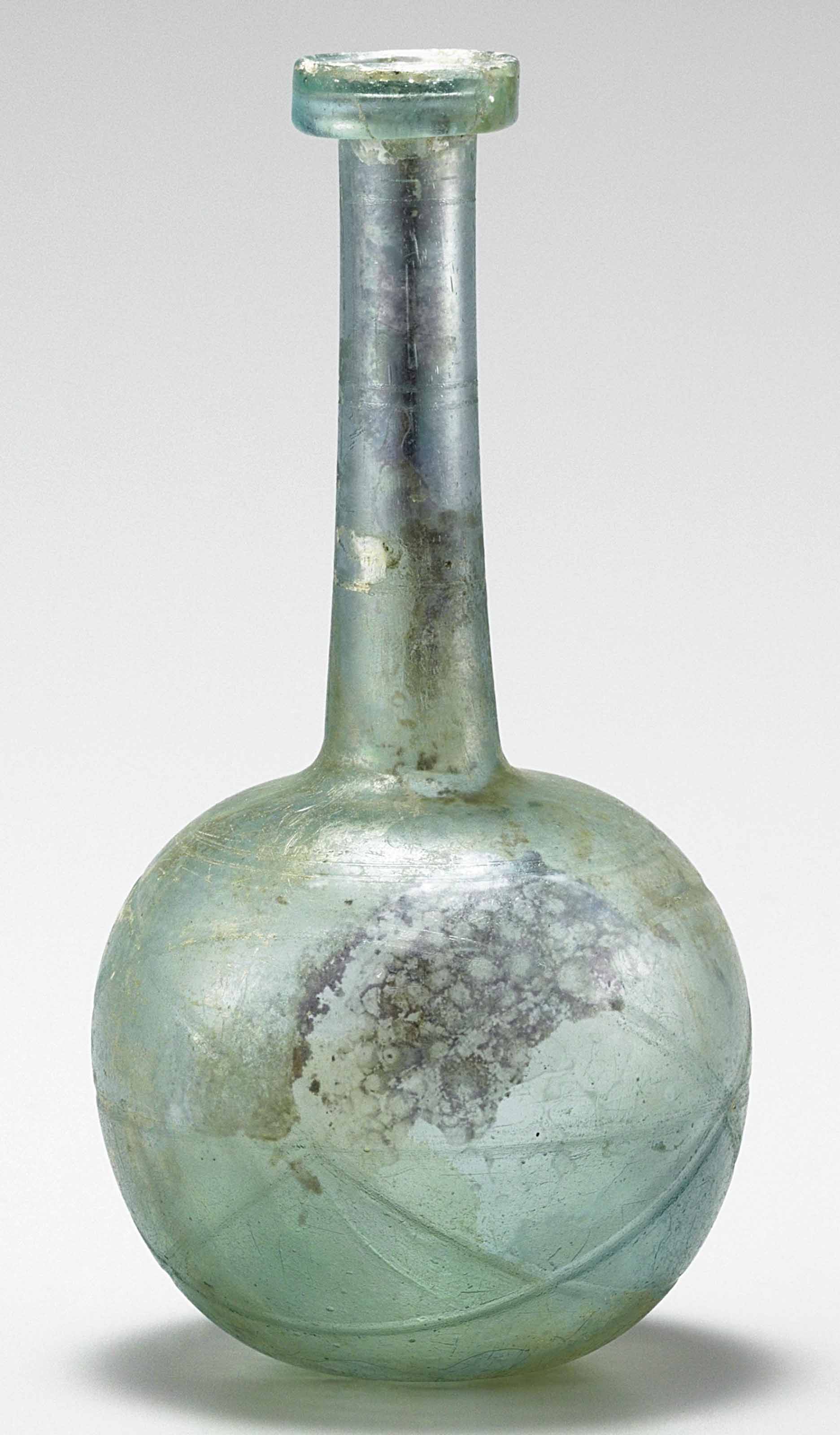 A ROMAN GLASS BOTTLE , EASTERN MEDITERRANEAN, CIRCA SECOND HALF OF THE ...
