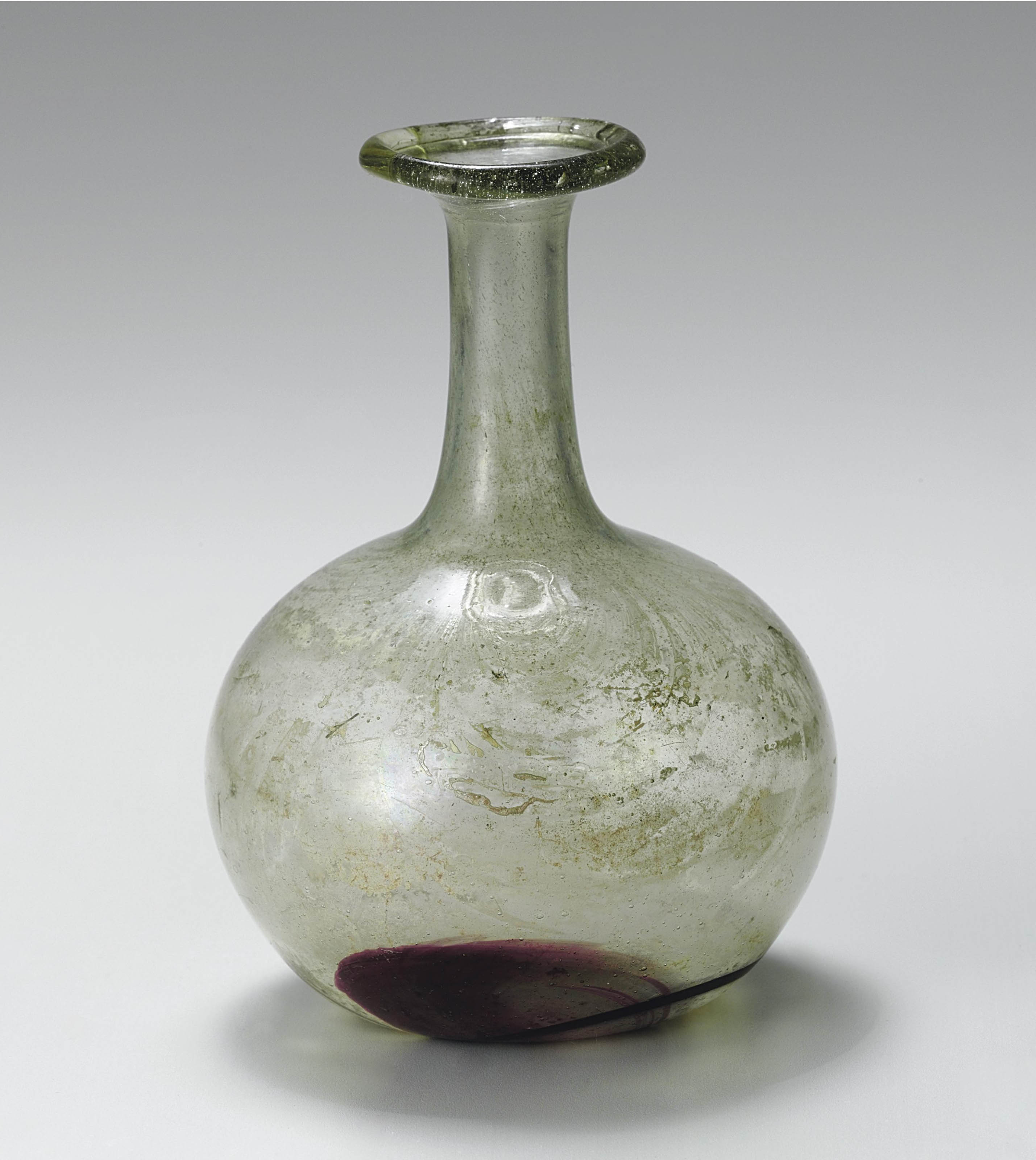 A LATE ROMAN GLASS BOTTLE , CIRCA 4TH-5TH CENTURY A.D. | Christie's