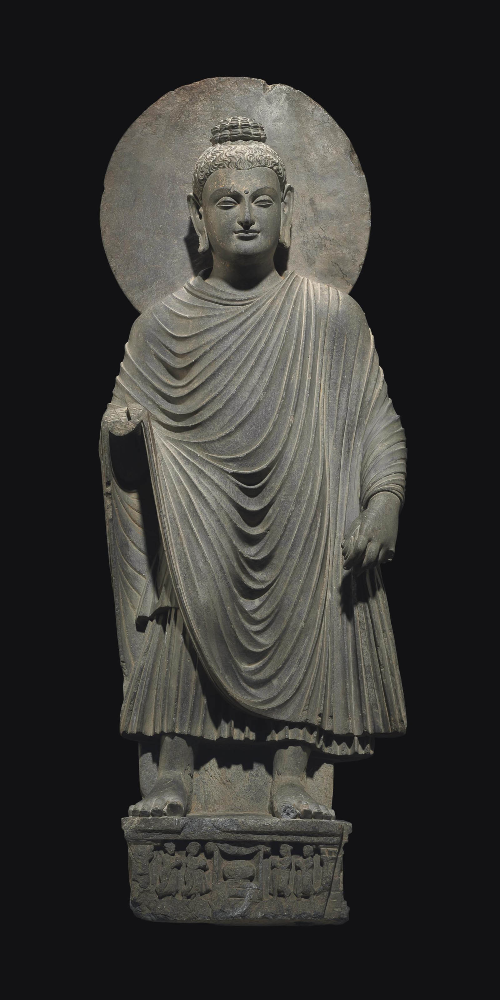 A large gray schist figure of a standing Buddha , GANDHARA, 2ND/3RD ...