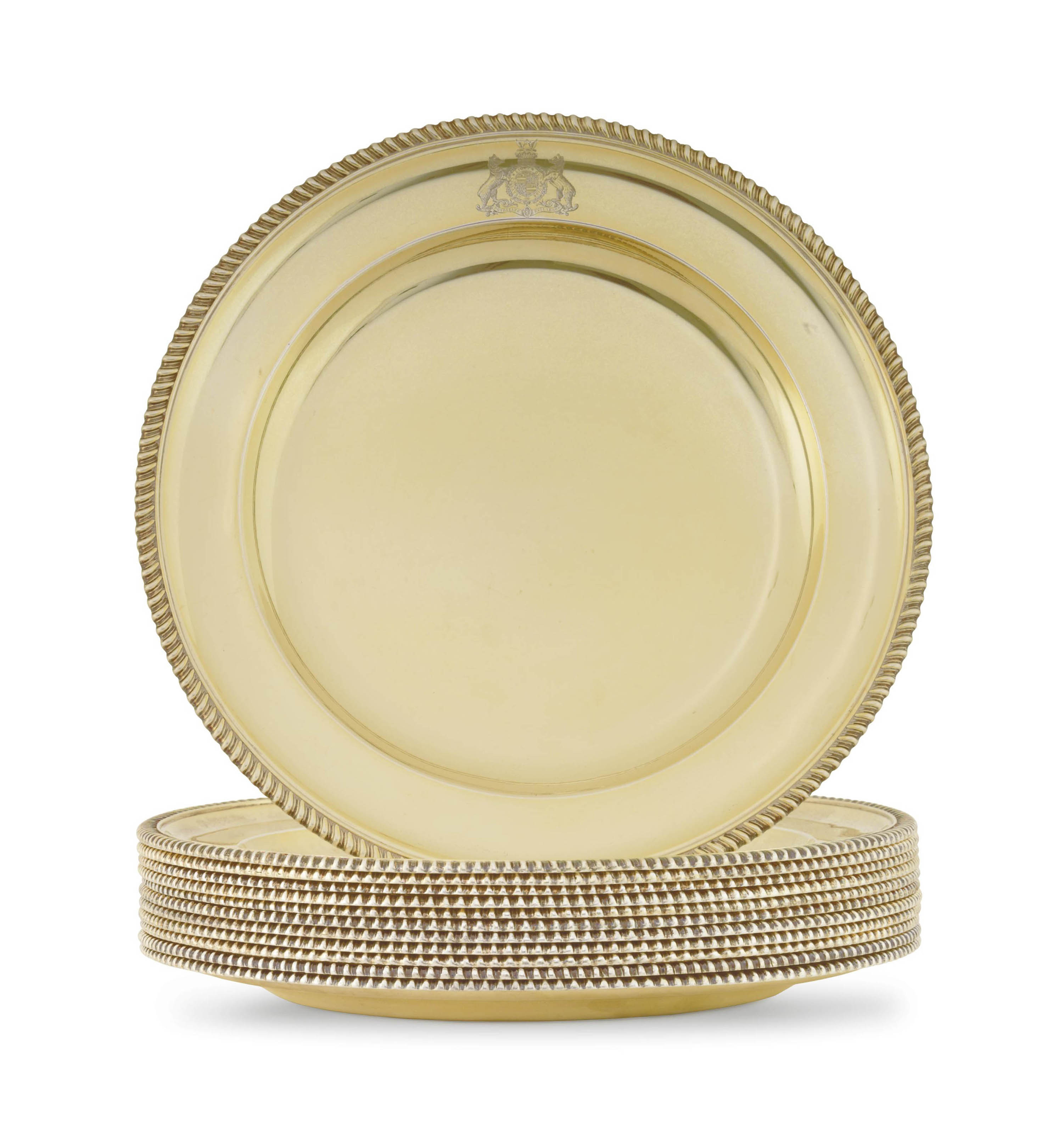 A SET OF TWELVE VICTORIAN SILVER-GILT DINNER PLATES