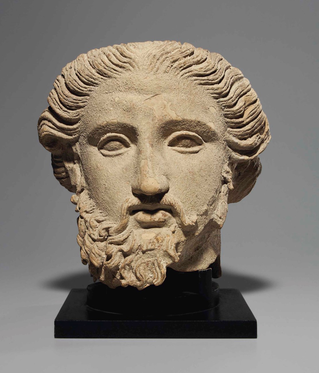 A GREEK TERRACOTTA HEAD OF A BEARDED GOD , TARANTINE, CIRCA MID 4TH ...