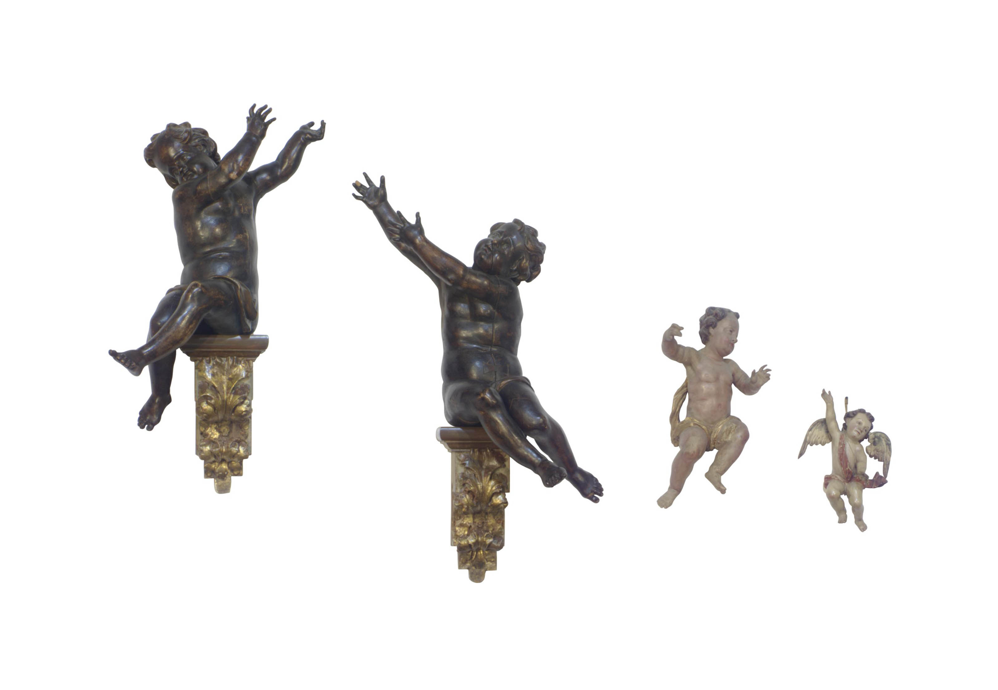 A PAIR OF CARVED AND STAINED WOOD FIGURES OF PUTTI, AND A POLYCHROME ...
