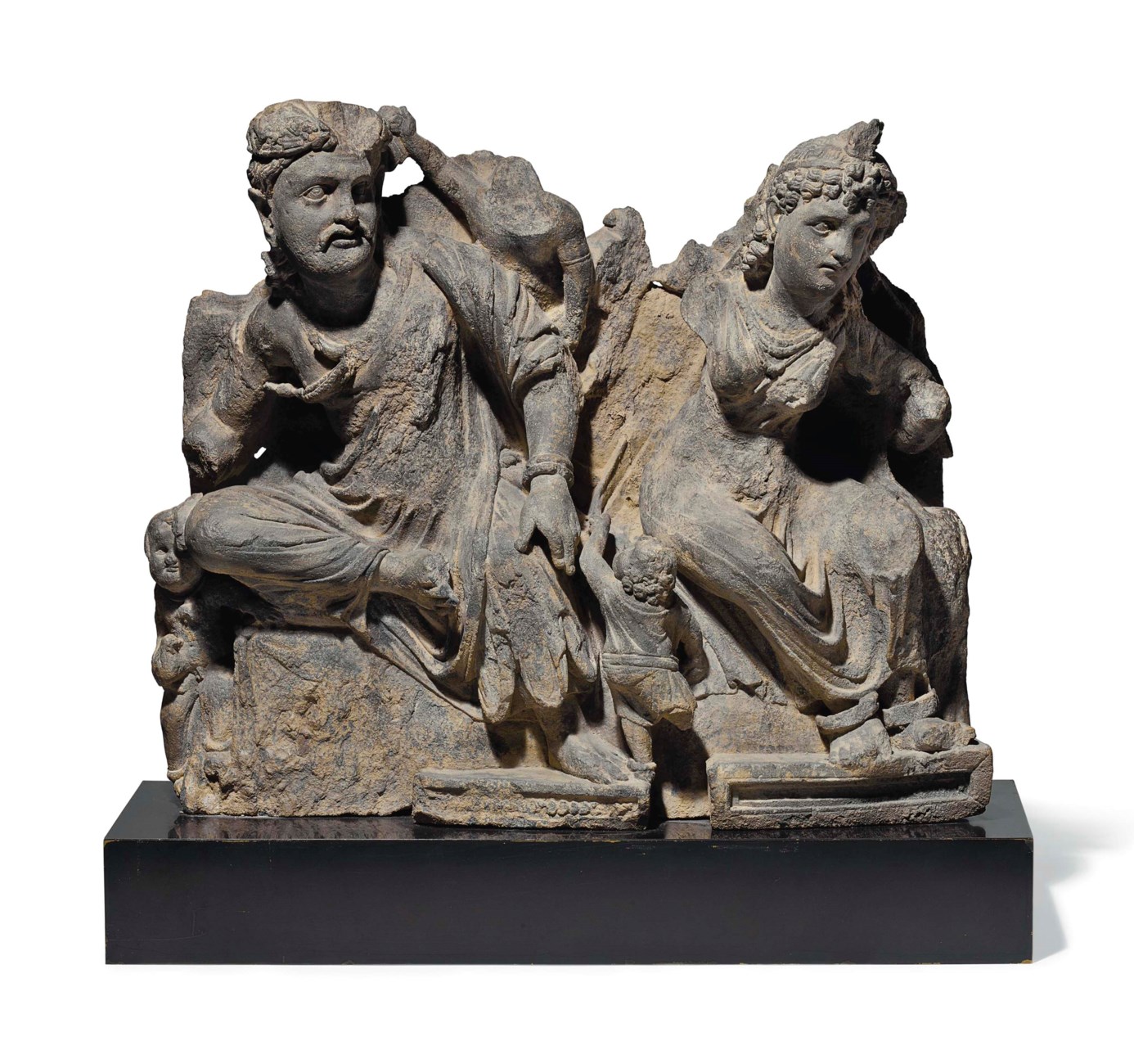 A gray schist relief of Panchika and Hariti , GANDHARA, 2ND/3RD CENTURY ...