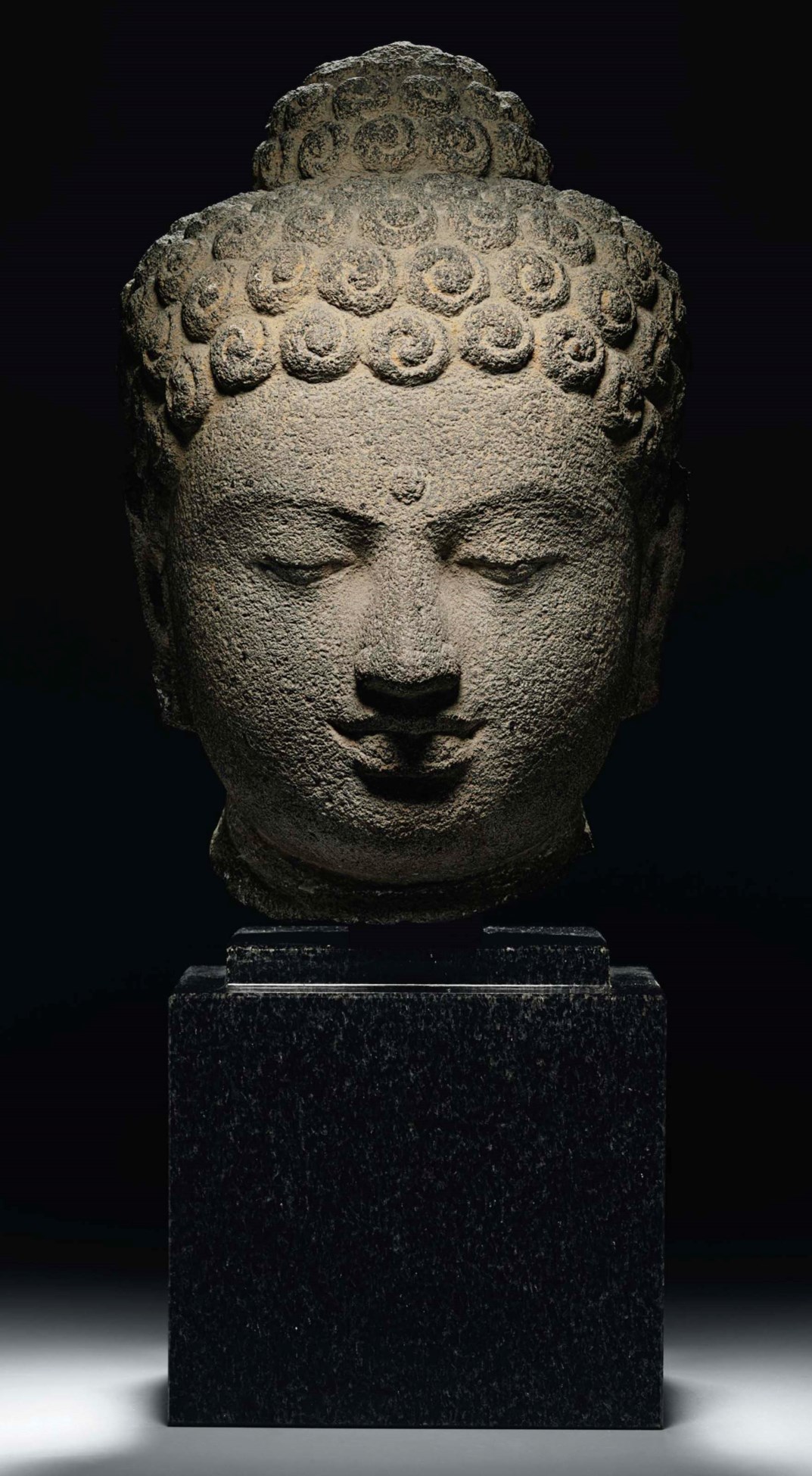 An andesite head of Buddha , INDONESIA, CENTRAL JAVA, 9TH CENTURY ...