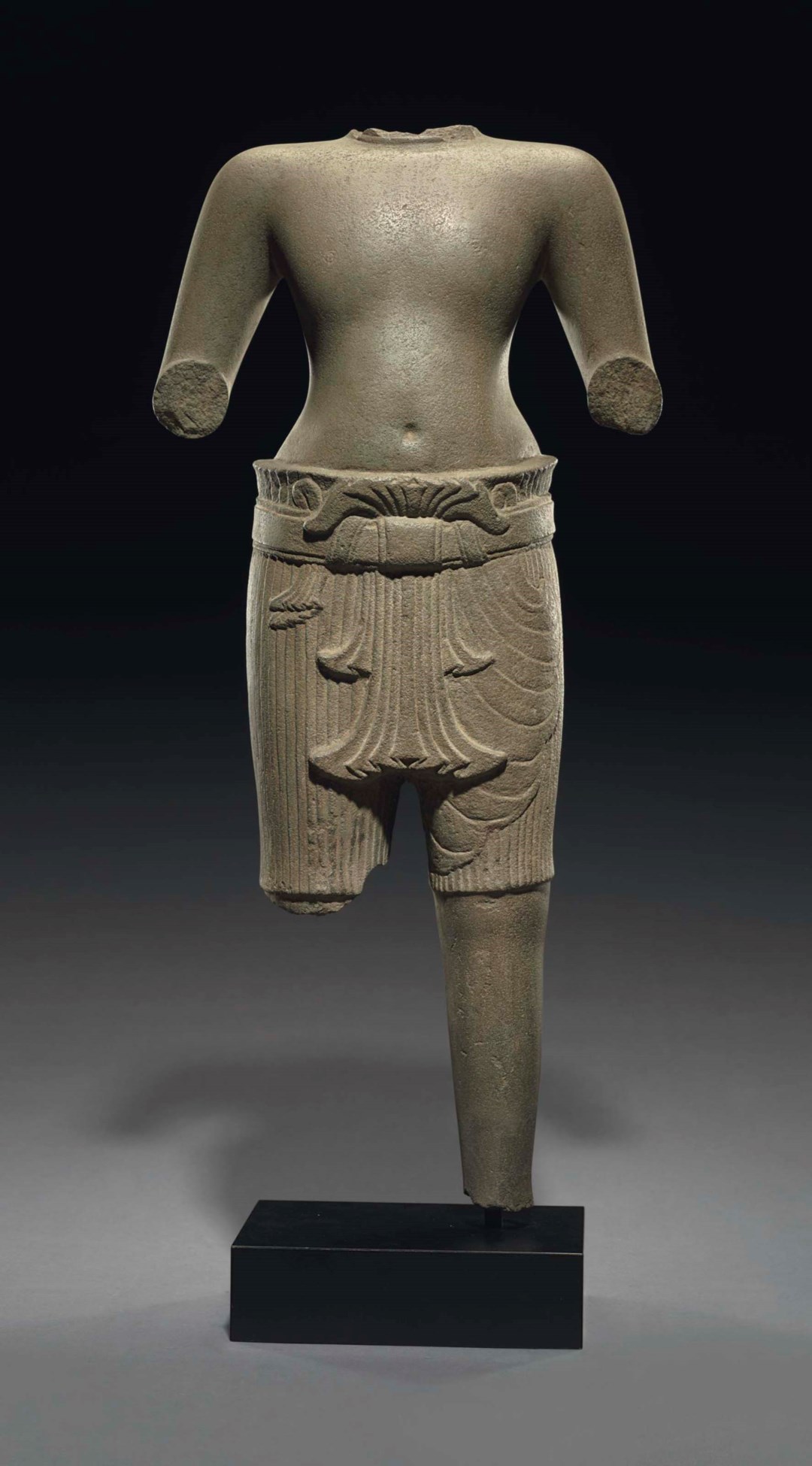 A sandstone torso of a male deity , KHMER, ANGKOR PERIOD, BAKHENG STYLE ...