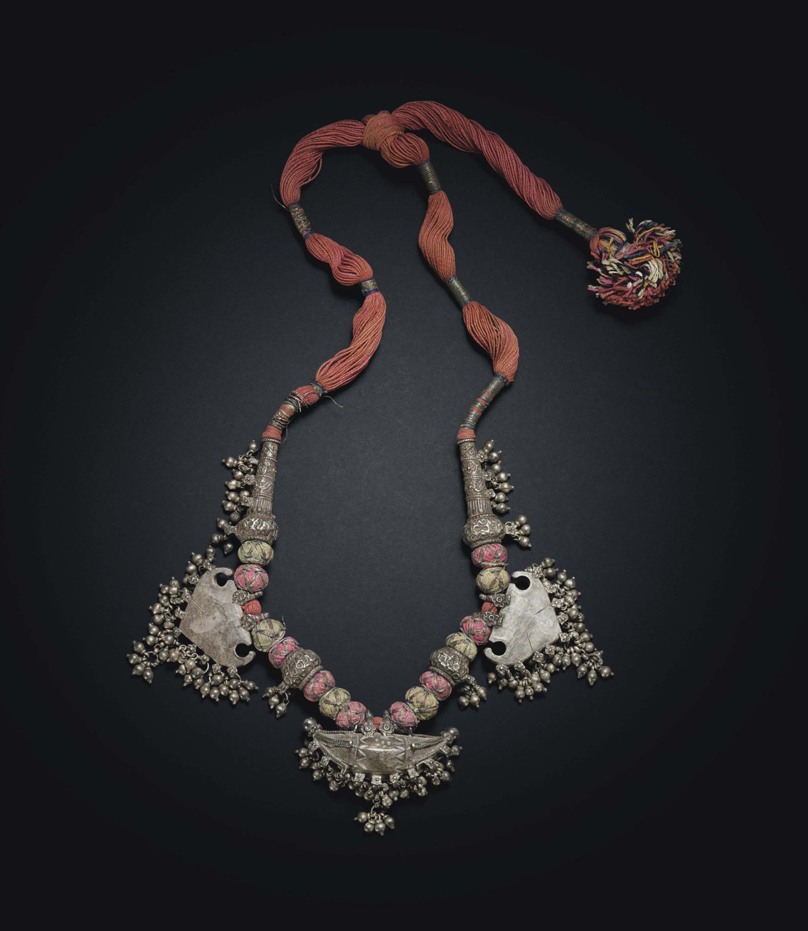 Two ceremonial glass-bead necklaces and three conch-shell ear covers ...