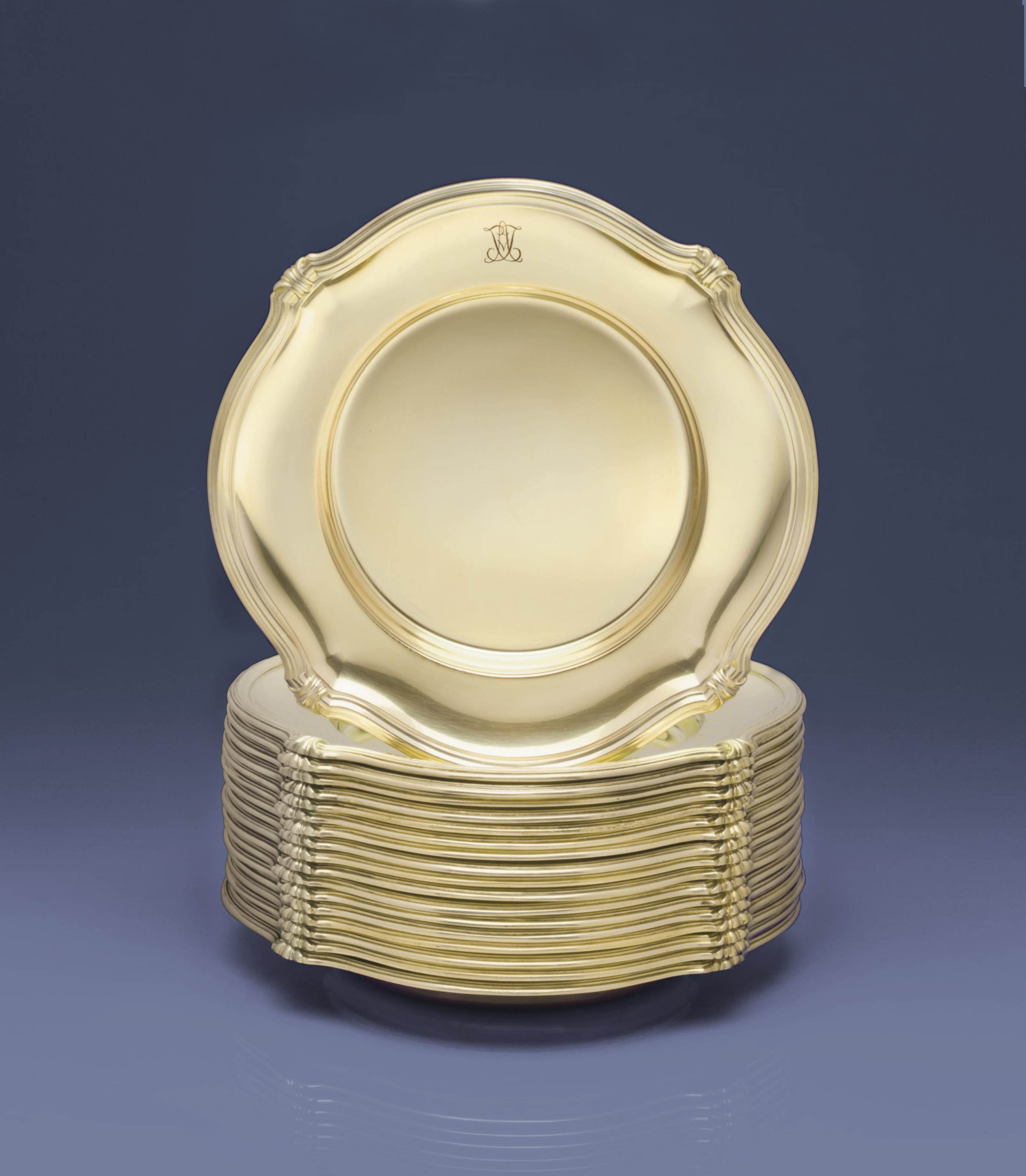 A SET OF EIGHTEEN FRENCH SILVER-GILT DESSERT PLATES