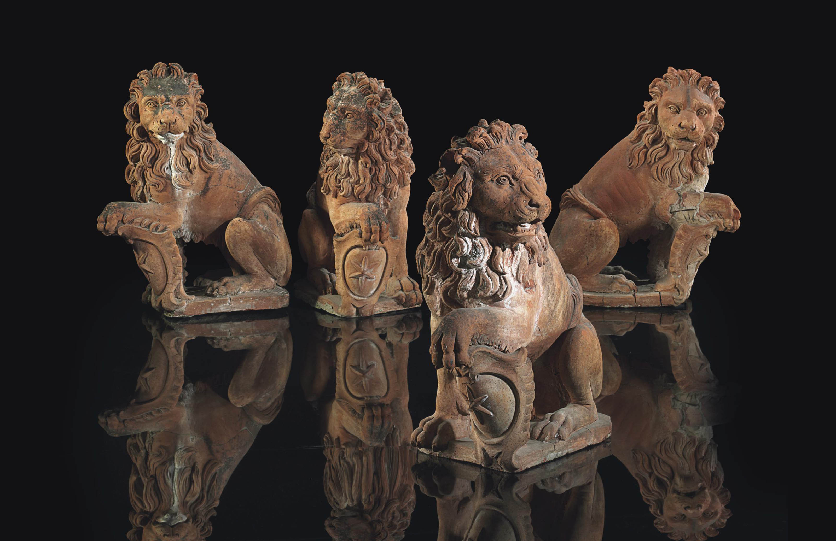 A SET OF FOUR TERRACOTTA FIGURES OF LIONS