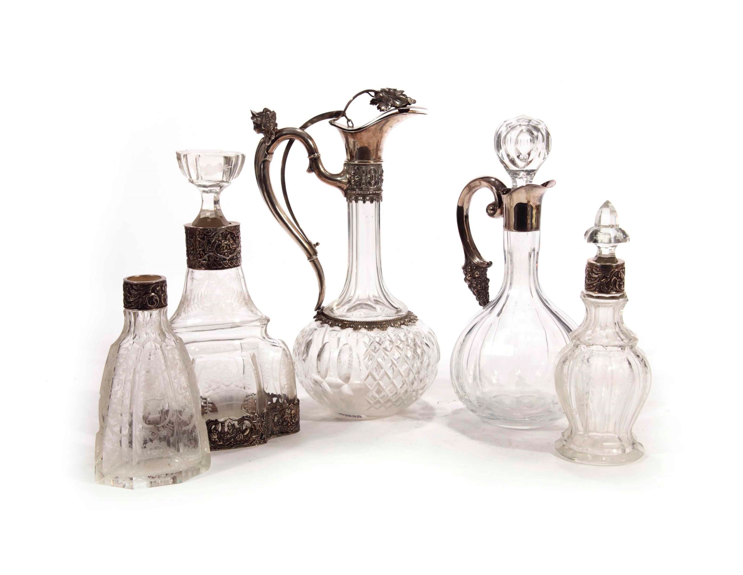 A collection of five silver-mounted glass decanters
