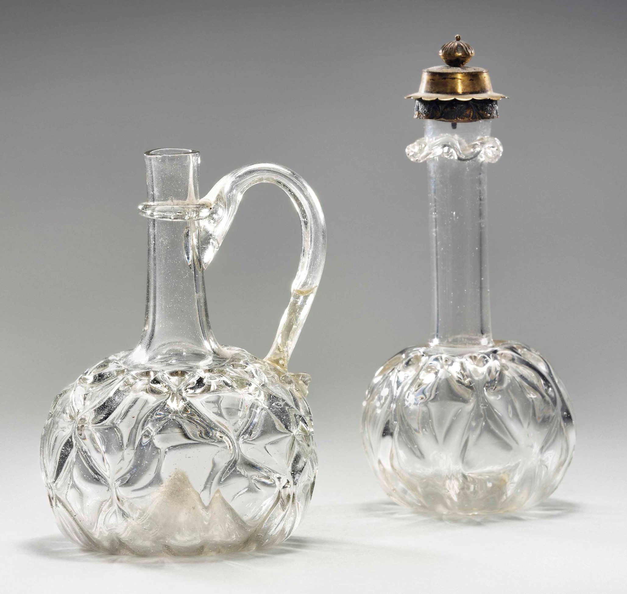 A MINIATURE GLASS FLASK AND SILVER-GILT COVER AND A CARAFE , CIRCA 1700 ...