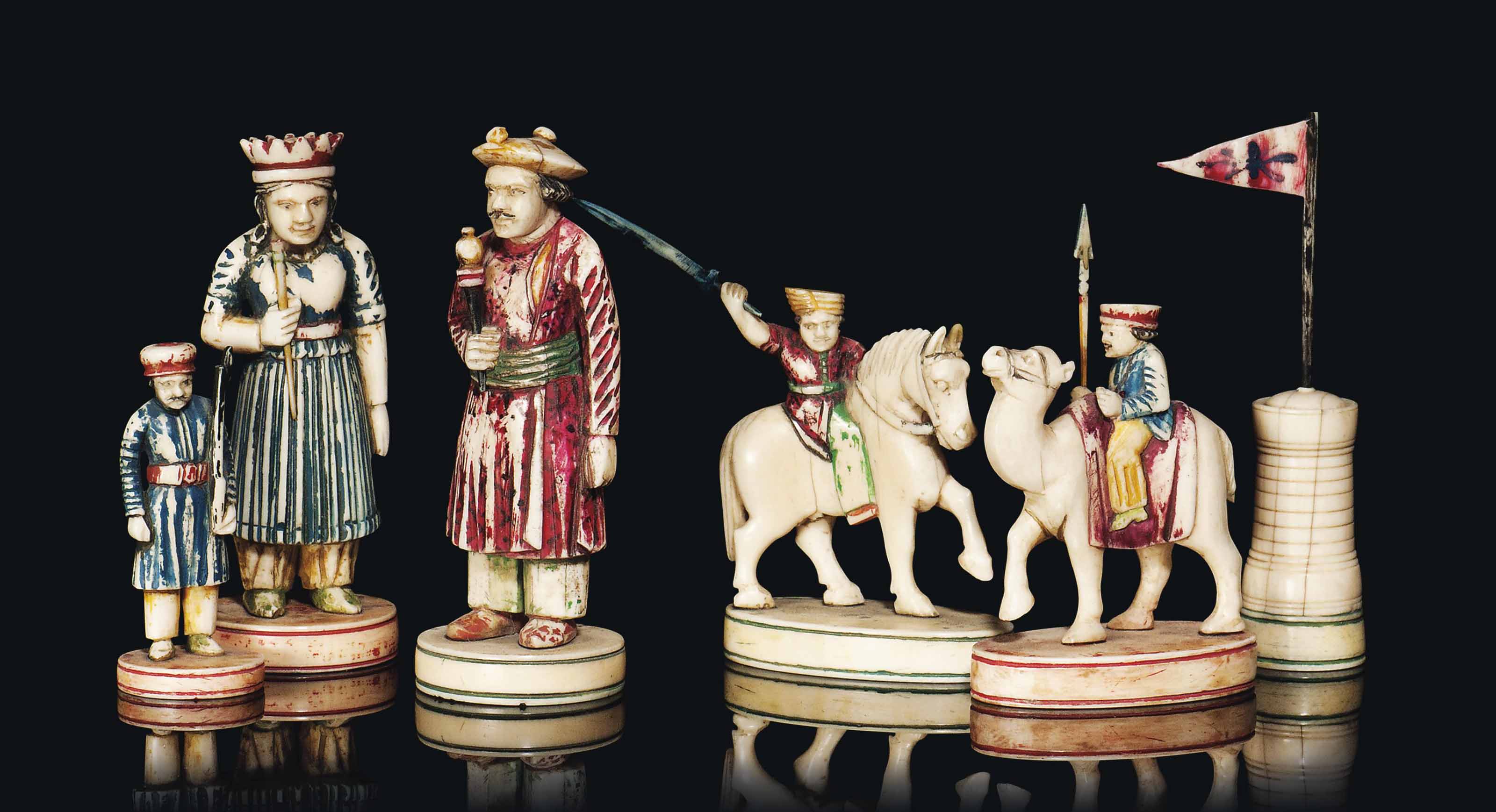 AN INDIAN GILT-HEIGHTENED POLYCHROME IVORY FIGURAL CHESS SET ...