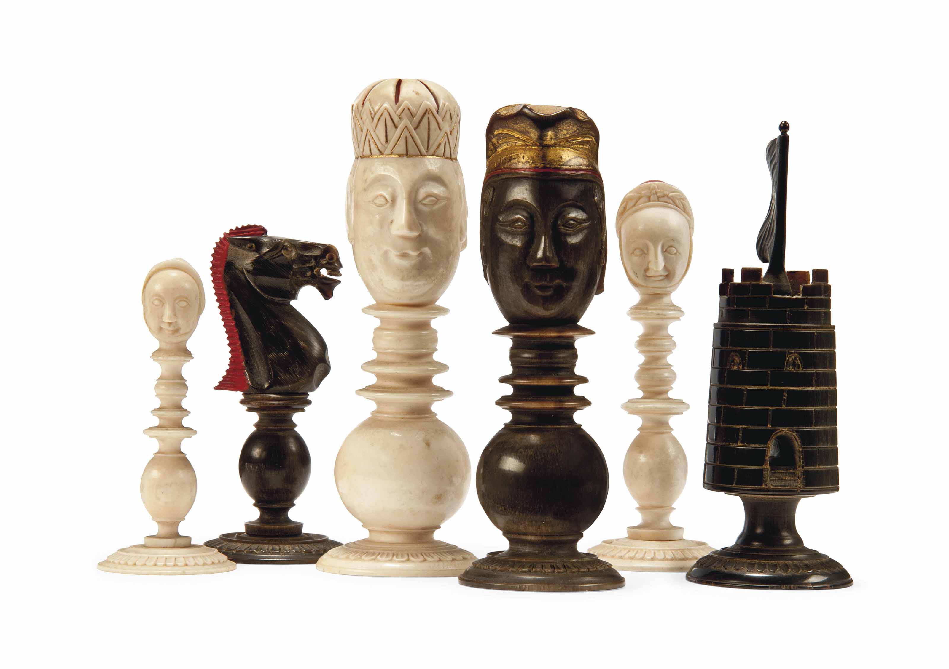 AN INDIAN GILT-HEIGHTENED POLYCHROME IVORY FIGURAL CHESS SET ...