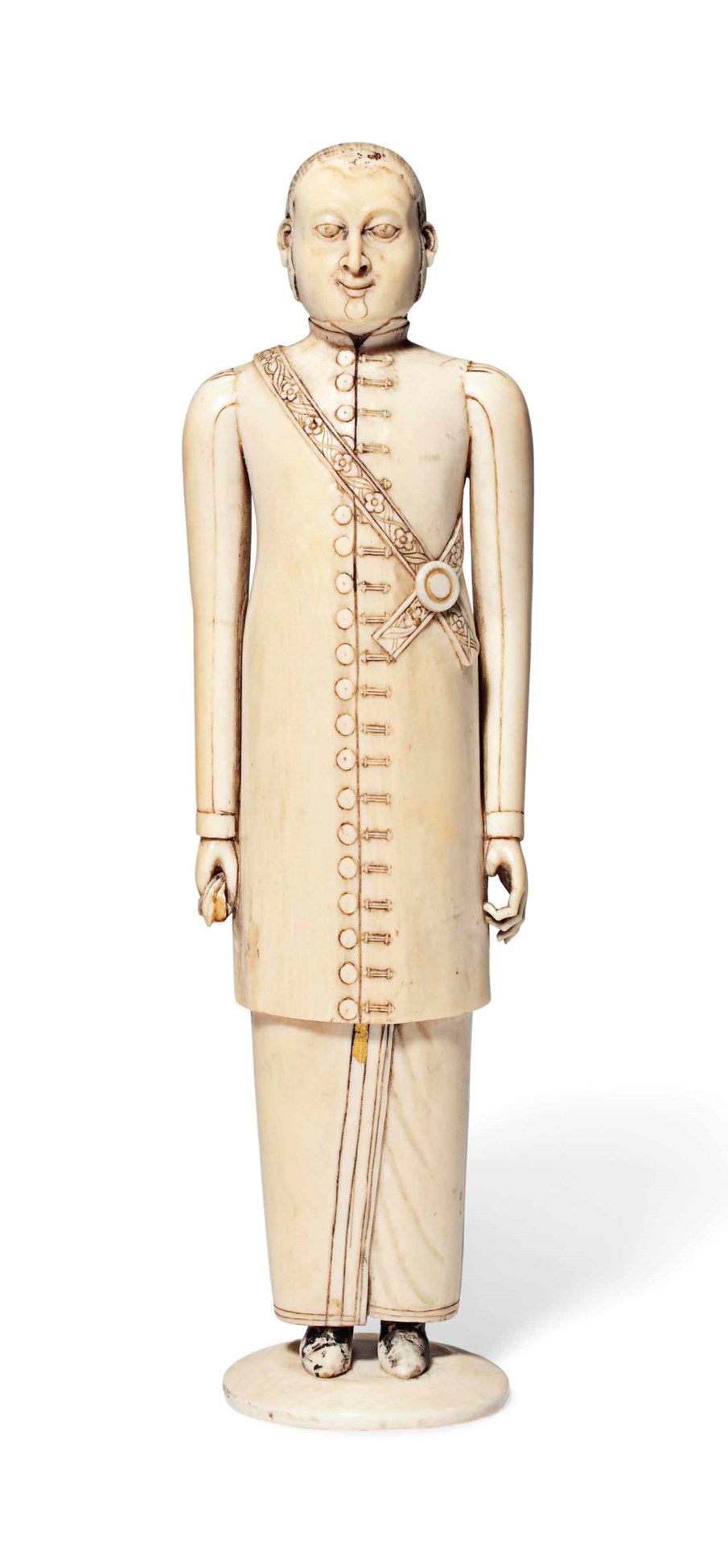 A CARVED IVORY FIGURE OF A COLONIAL OFFICIAL
