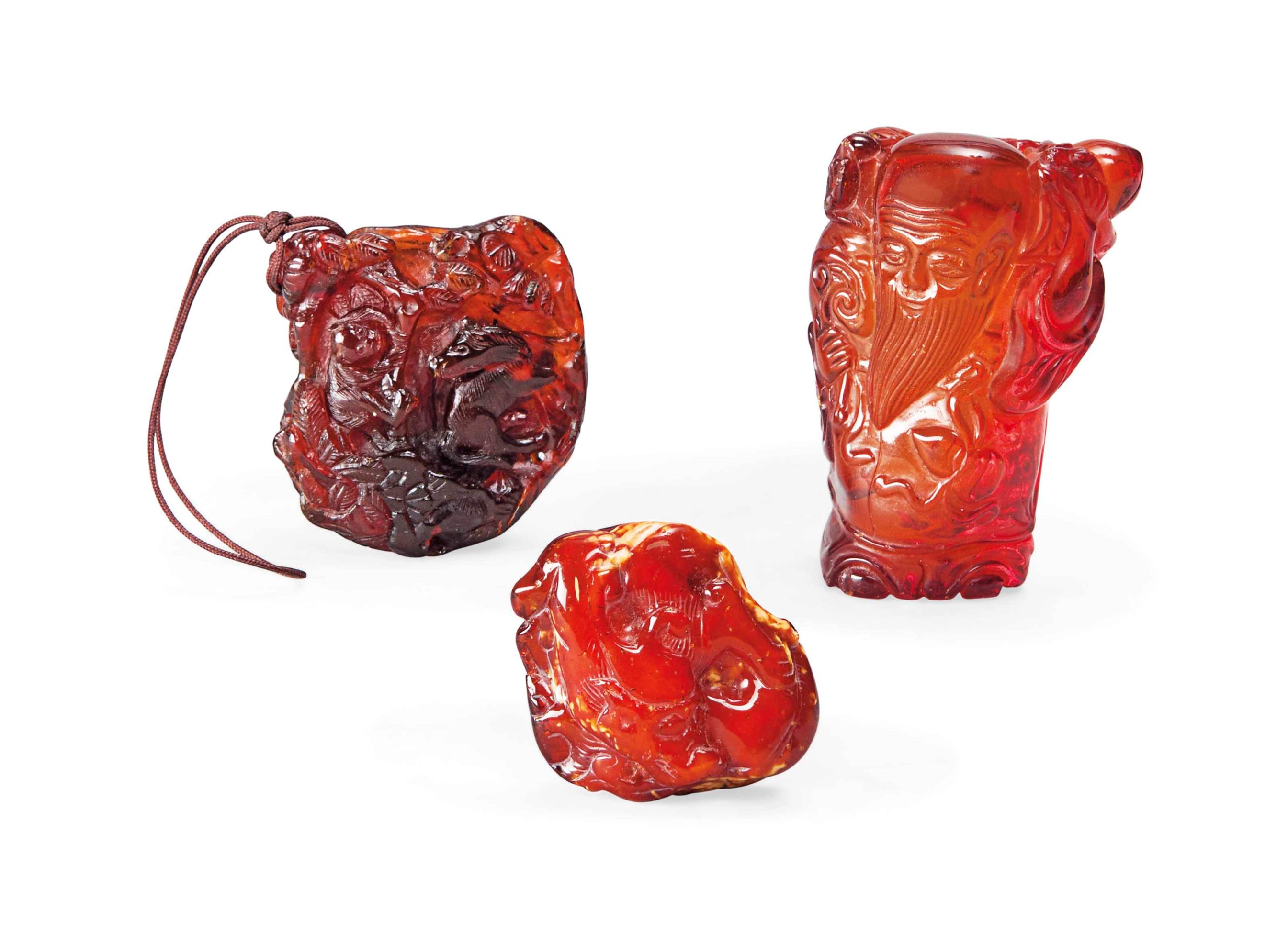THREE CHINESE AMBER CARVINGS, 20TH CENTURY | Christie's