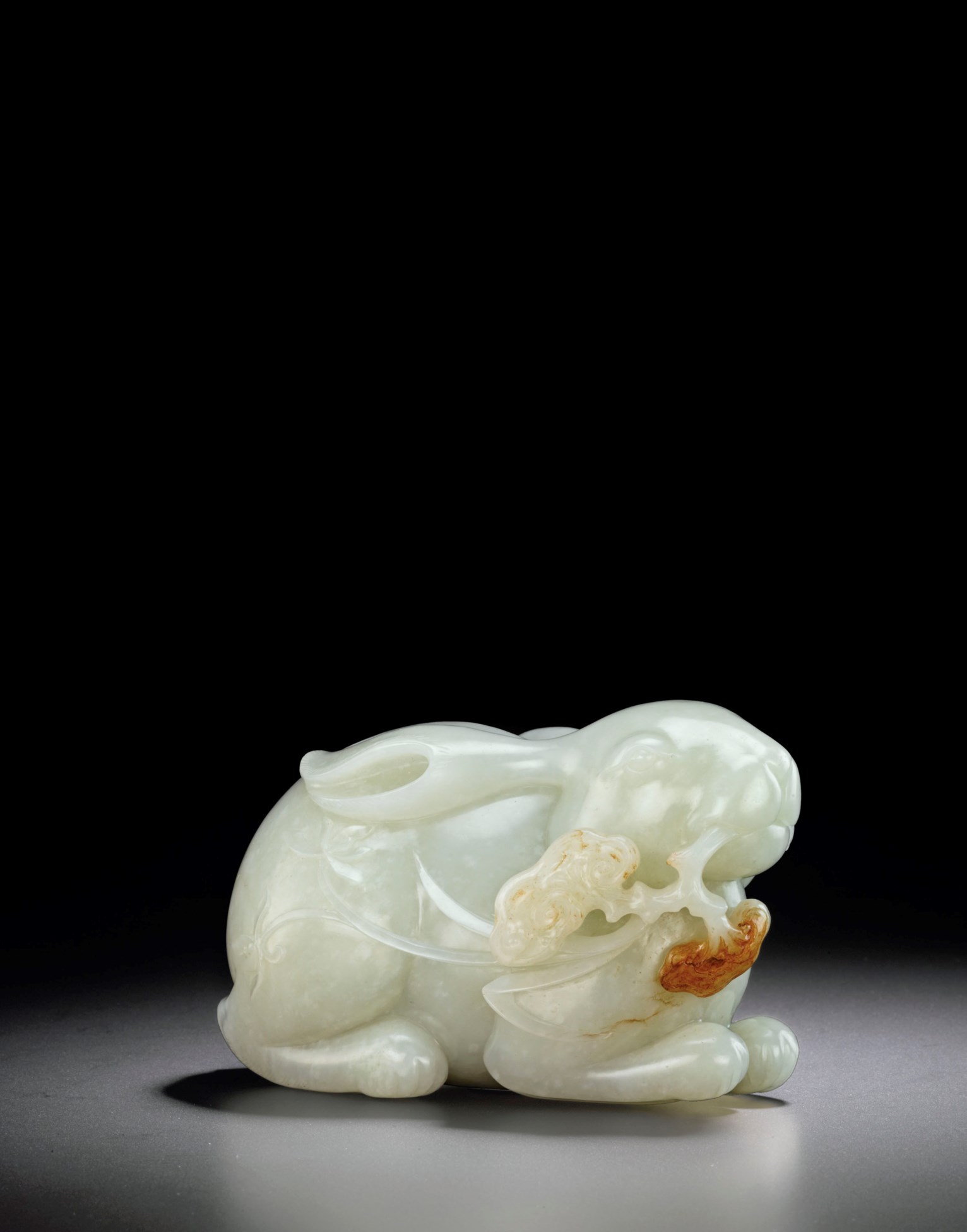 A LARGE WHITE JADE CARVING OF A RABBIT