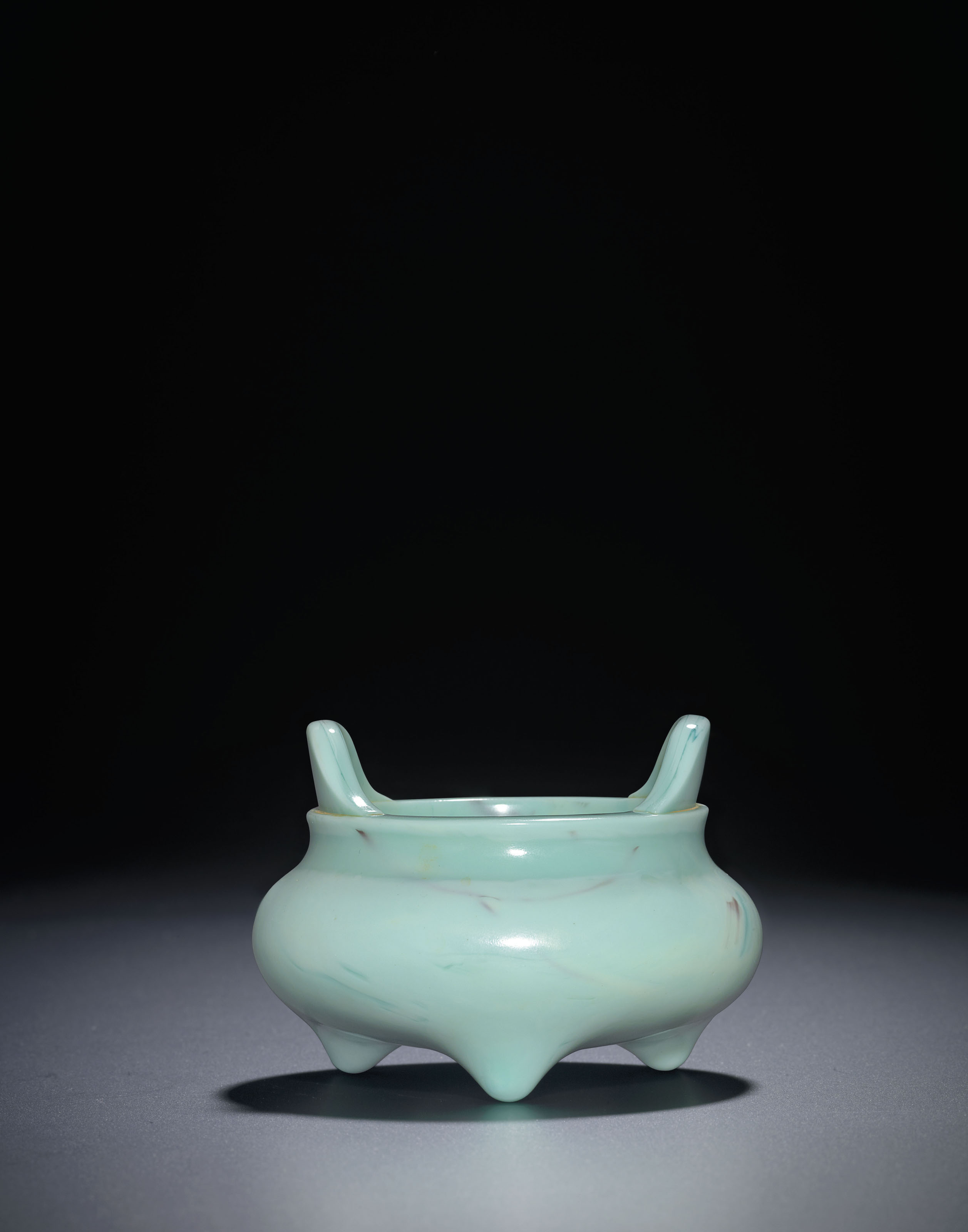 AN OPAQUE TURQUOISE GLASS TRIPOD CENSER