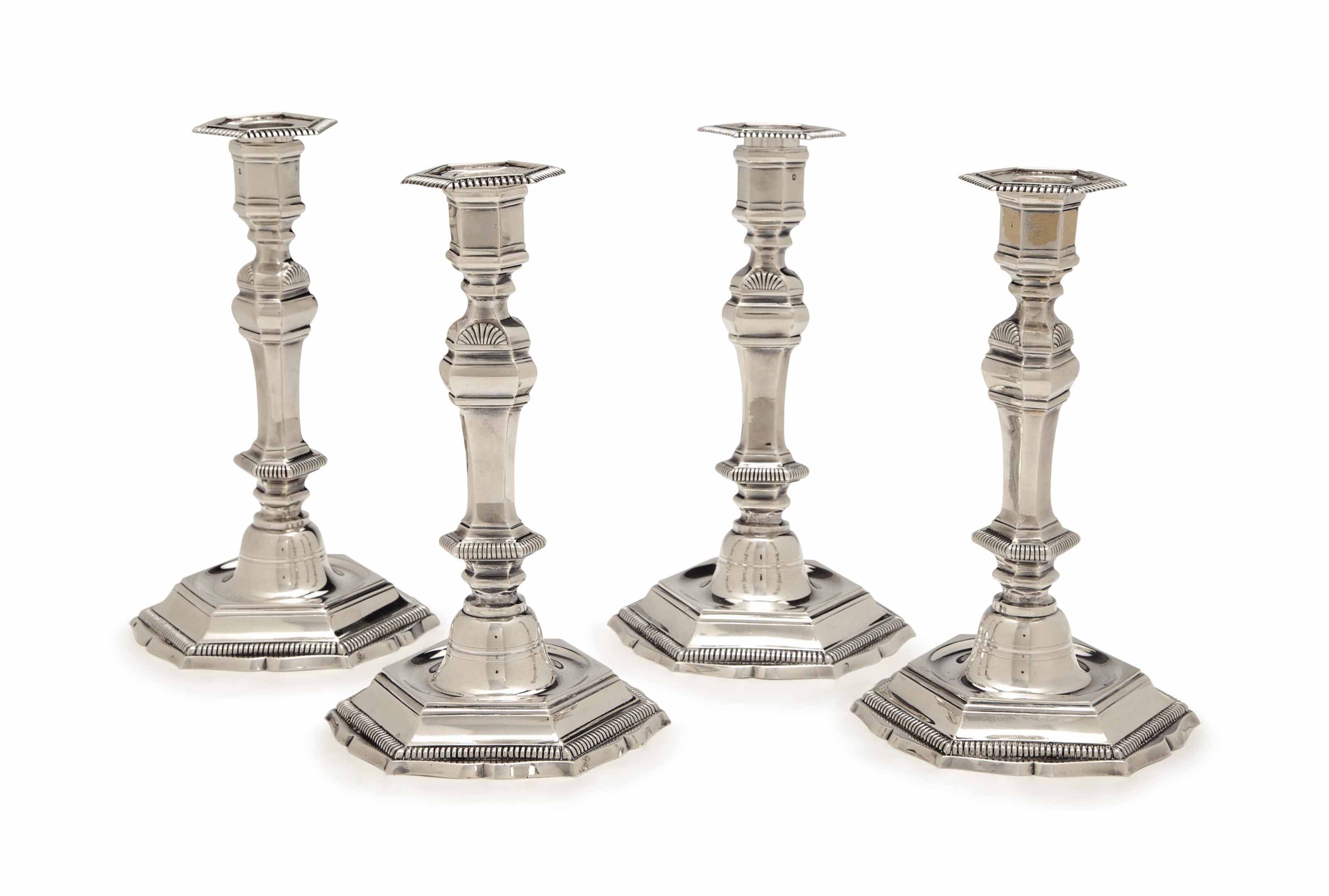 A SET OF FOUR FRENCH SILVER CANDLESTICKS,