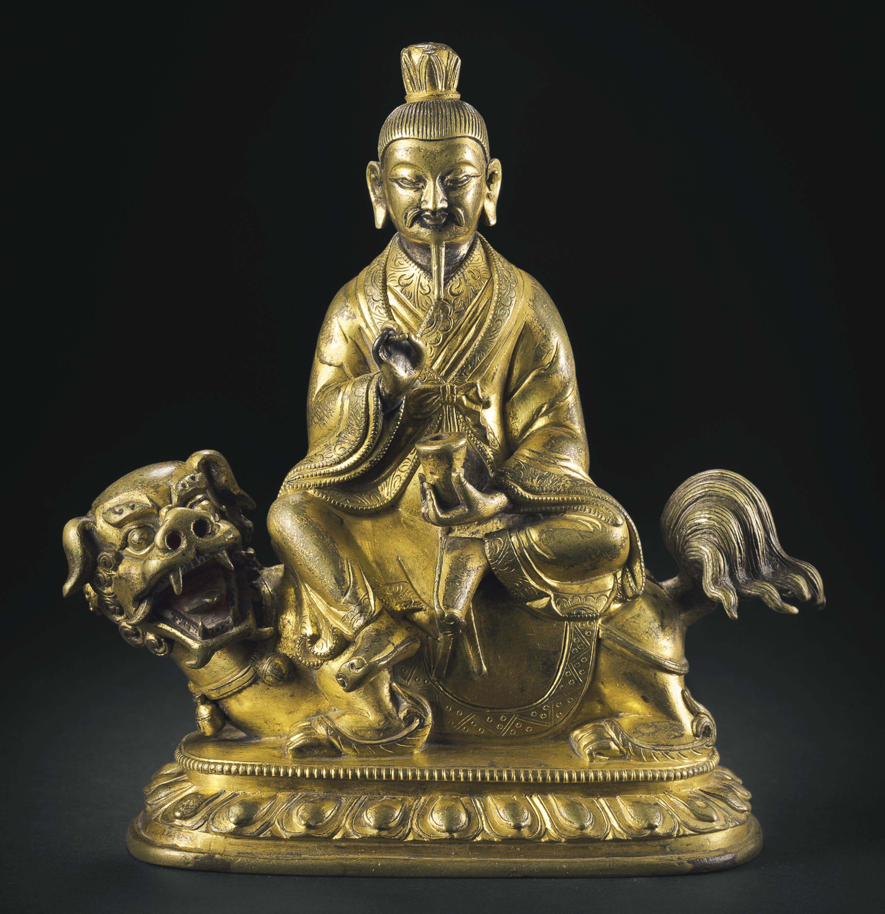 A gilt bronze figure of a Daoist deity