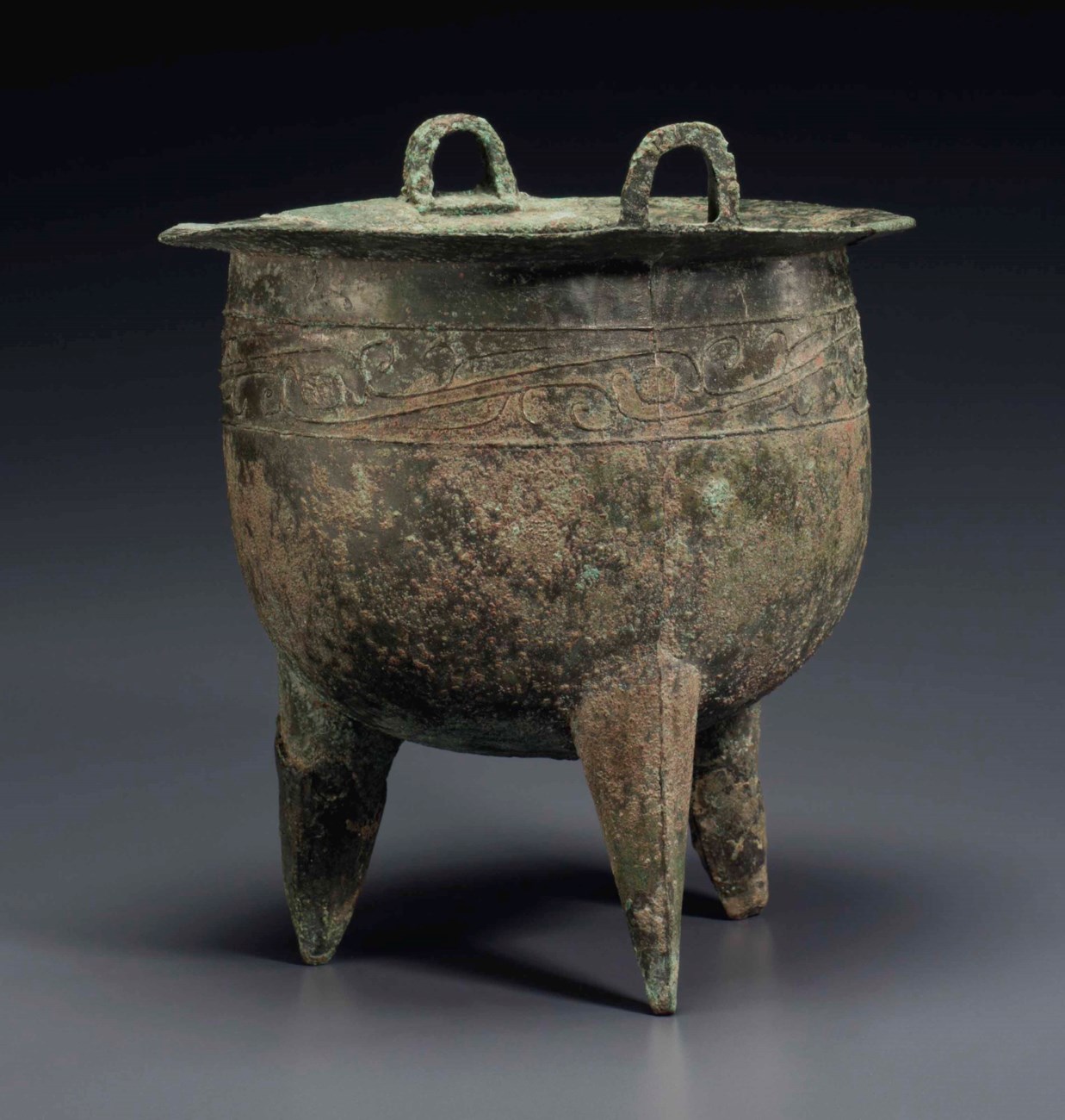 A BRONZE RITUAL TRIPOD FOOD VESSEL, DING , LATE XIA PERIOD, CIRCA 1600 ...