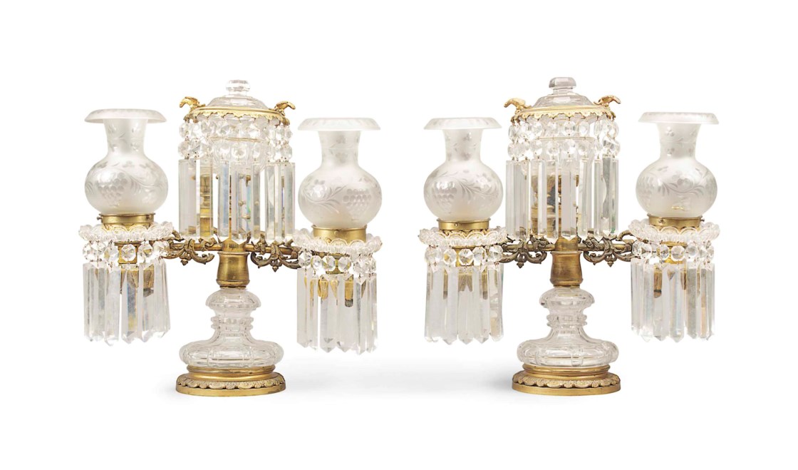 A PAIR OF GILT METAL AND CUT GLASS ARGAND LAMPS WITH TWO SHADES ...