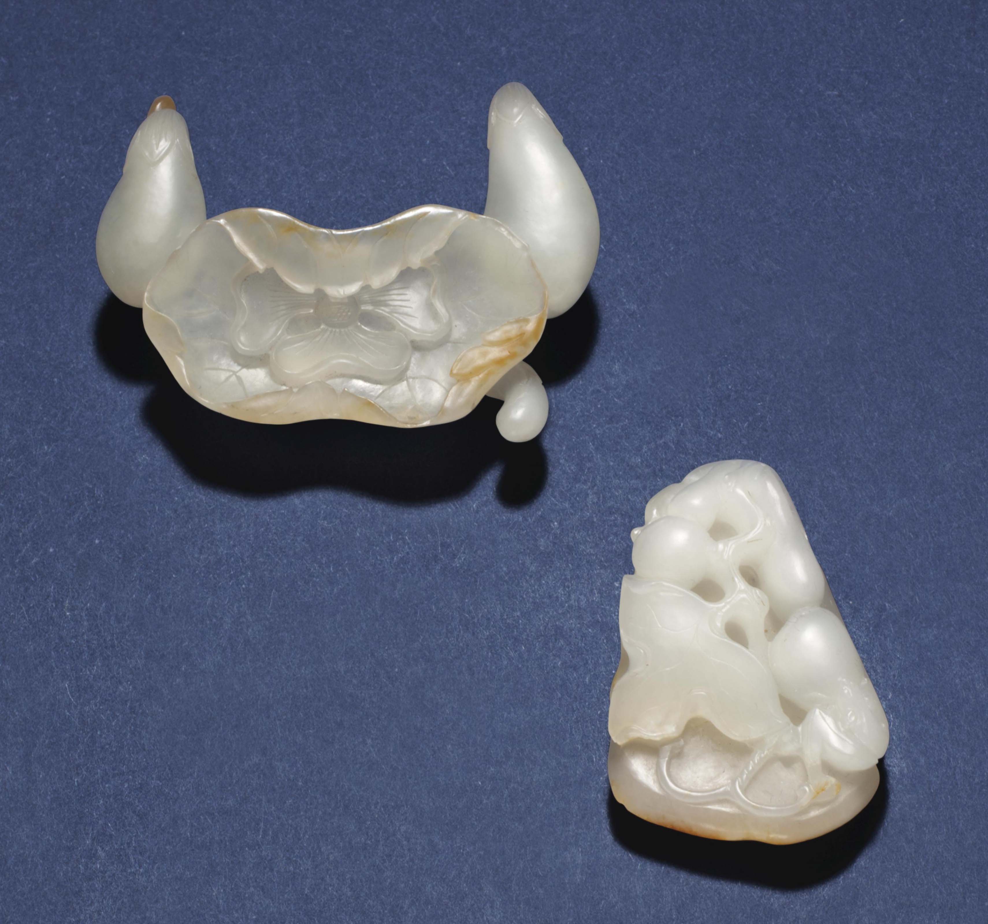 TWO WHITE AND RUSSET JADE PENDANTS