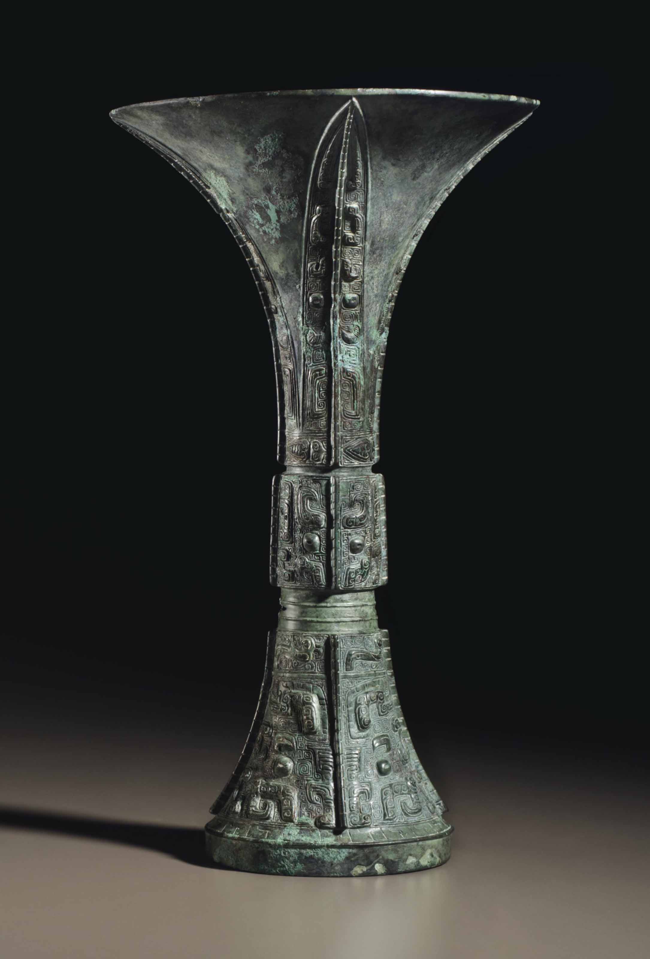 AN UNUSUAL BRONZE RITUAL WINE VESSEL, GU , LATE SHANG DYNASTY, ANYANG ...