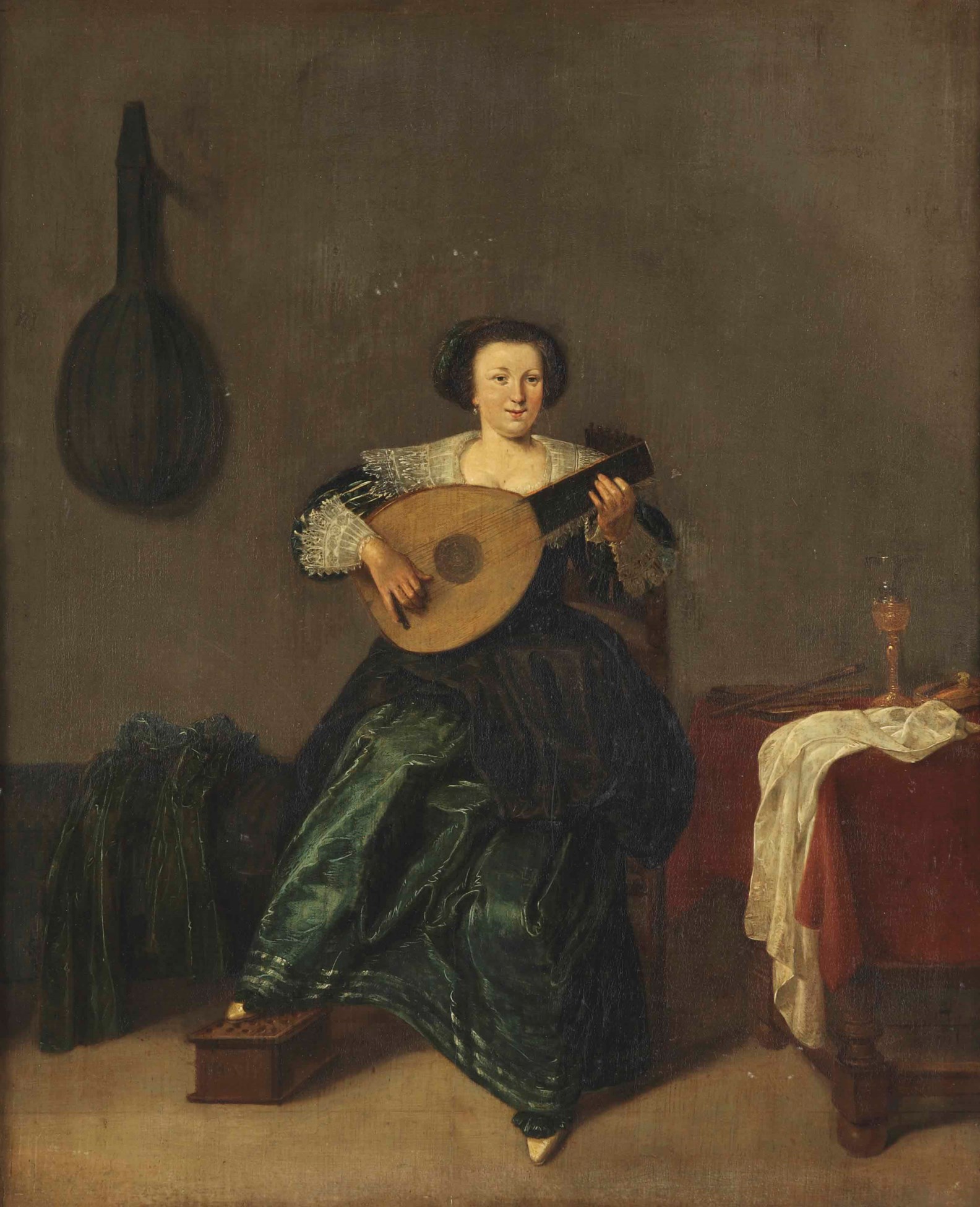 Dirck Hals (Haarlem 1591-1656) , An elegant lady in a green dress ...