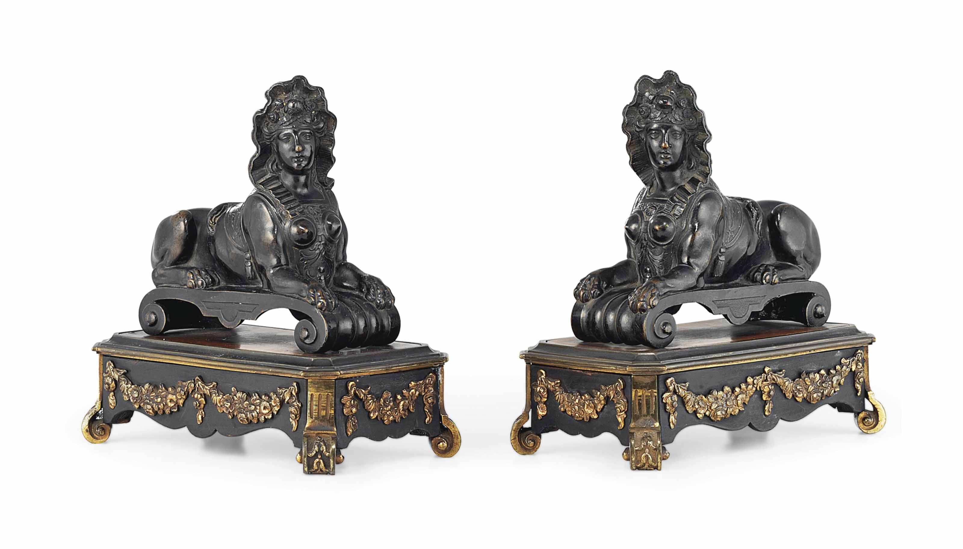 A PAIR OF BRONZE MODELS OF SPHINXES