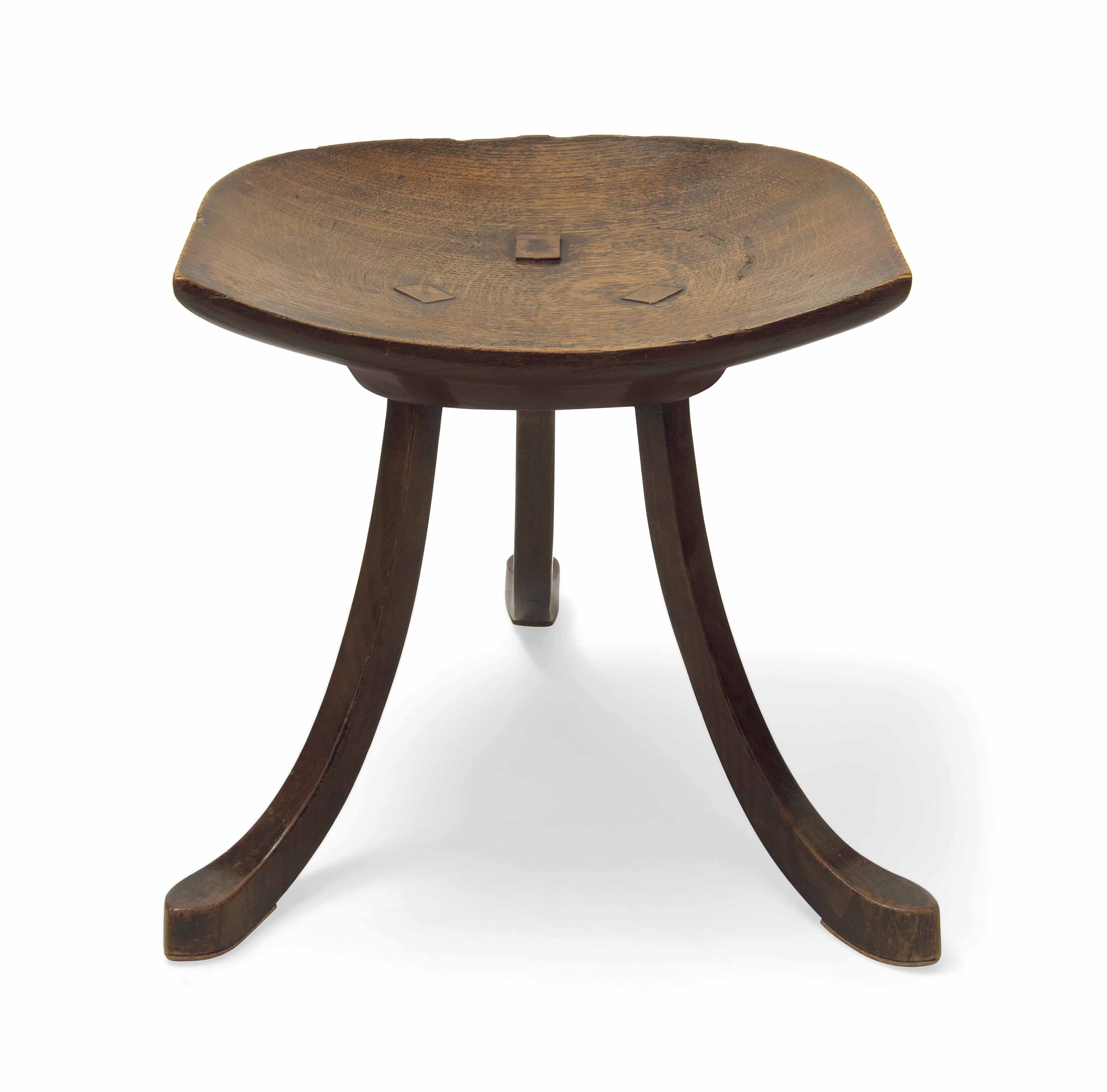 A LIBERTY & CO OAK 'THEBES' STOOL