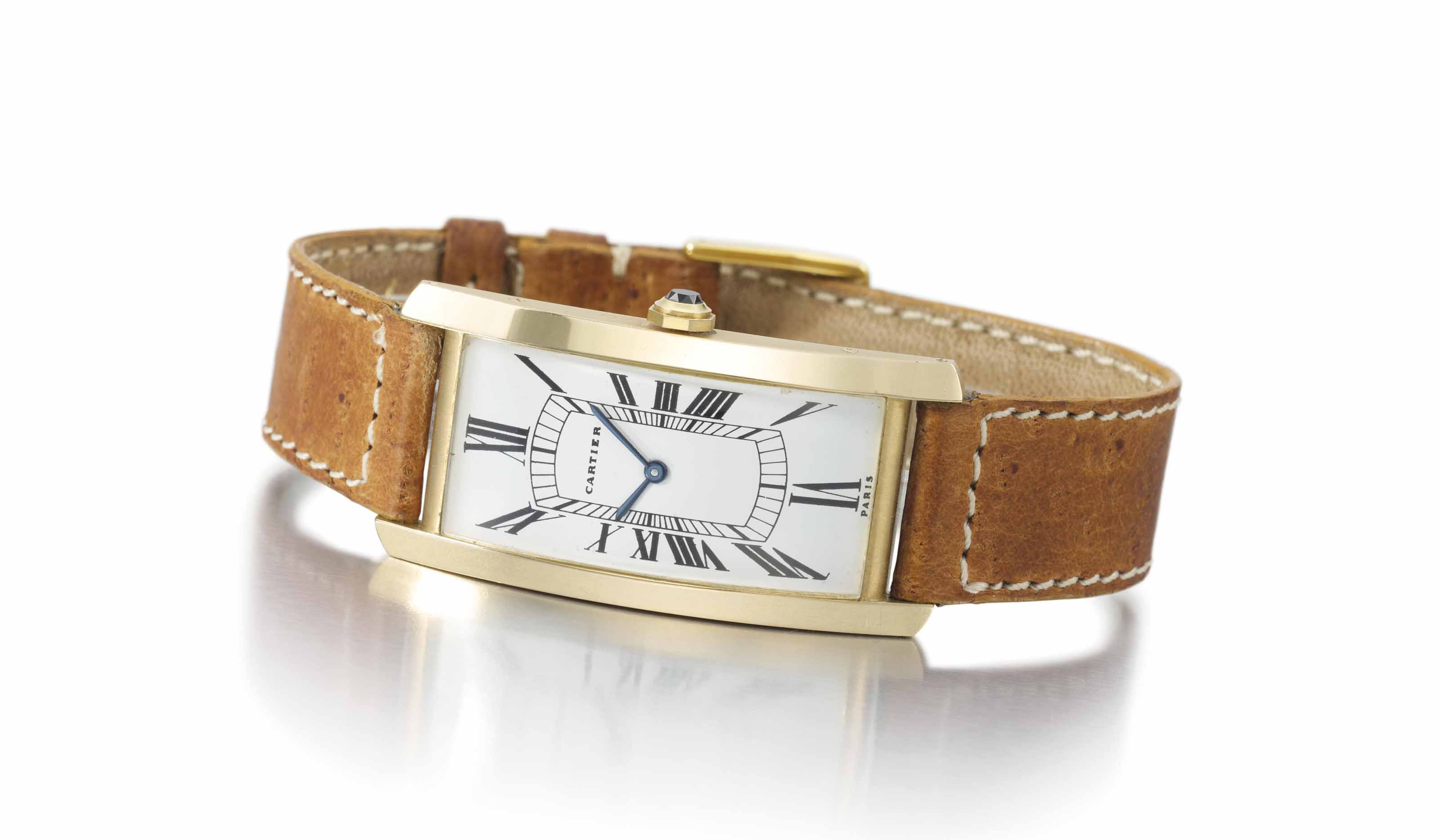 Cartier. A fine and rare large 18k gold rectangular curved wristwatch
