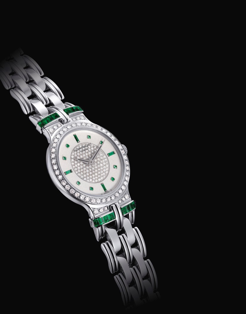 PATEK PHILIPPE. A FINE AND RARE 18K WHITE GOLD, DIAMOND AND EMERALD-SET ...