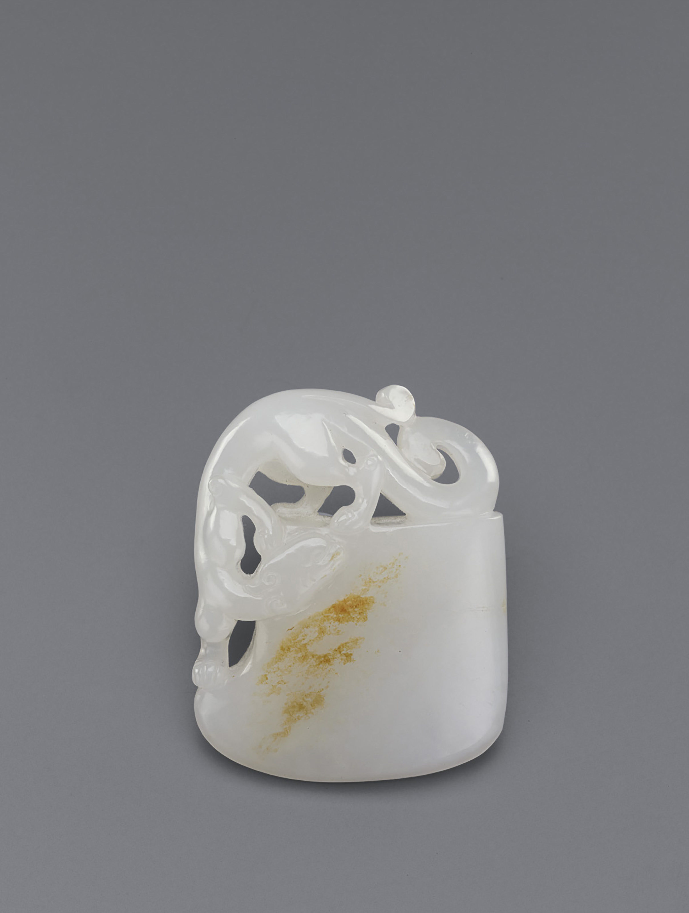 A CARVED WHITE JADE 'DRAGON' AX-SHAPED PENDANT