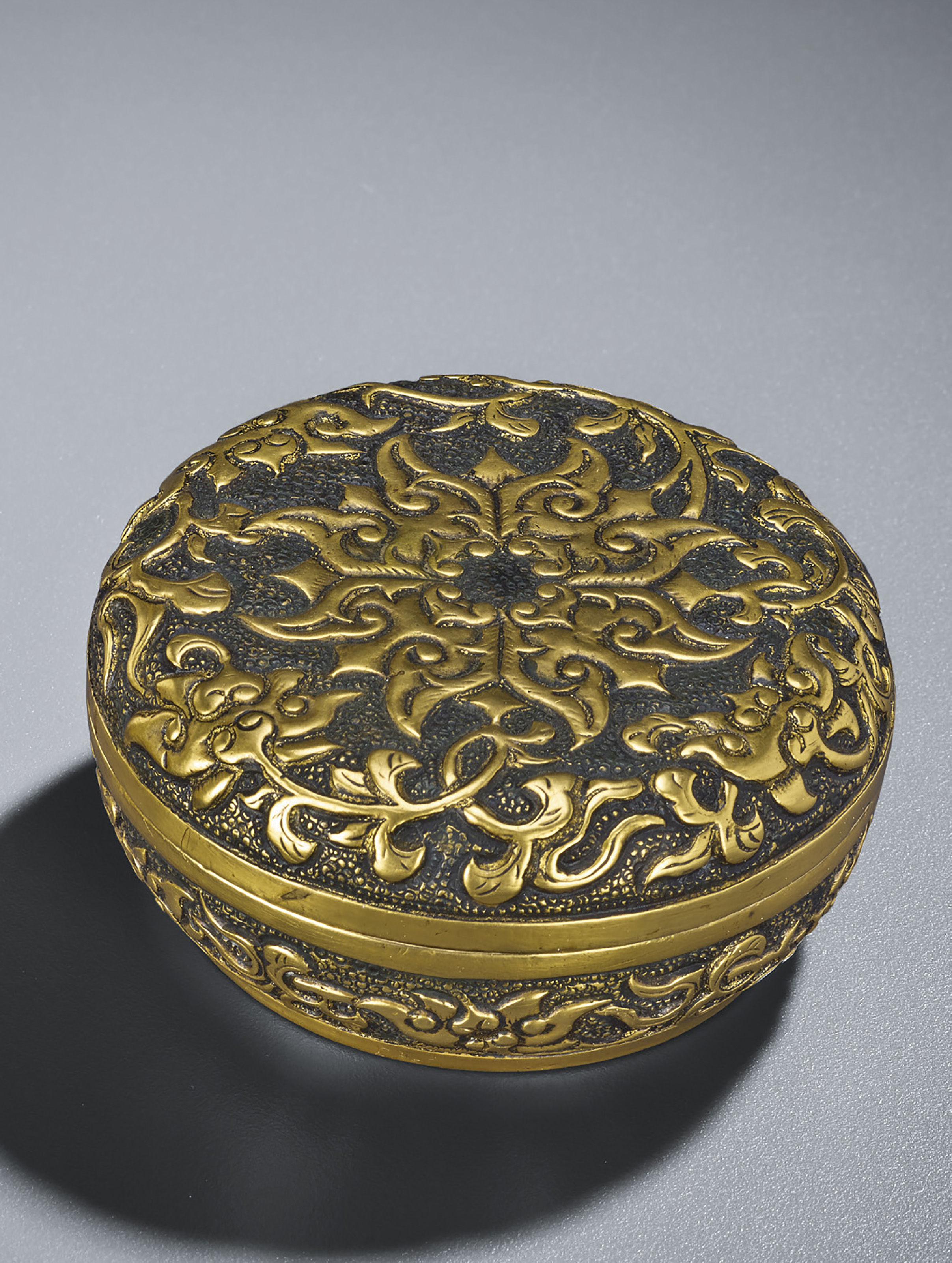 A PARCEL-GILT BRONZE INCENSE BOX AND COVER