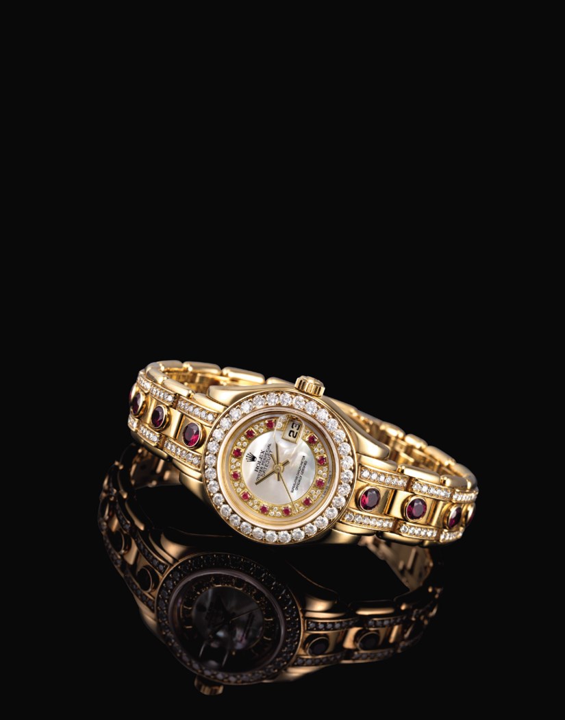 ROLEX. A LADY'S FINE 18K GOLD, DIAMOND AND RUBY-SET AUTOMATIC ...