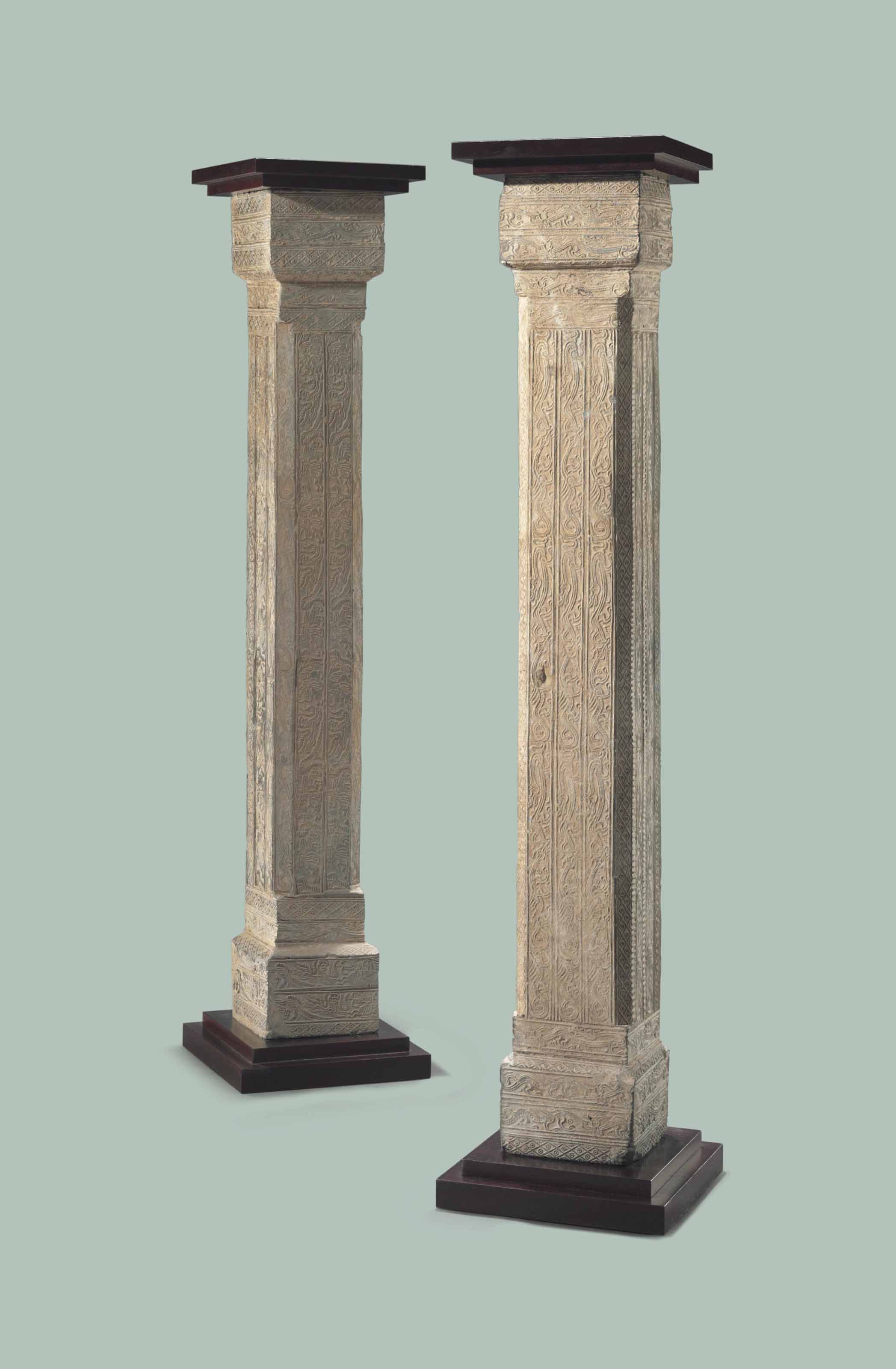 TWO MOLDED GREY POTTERY PILLARS