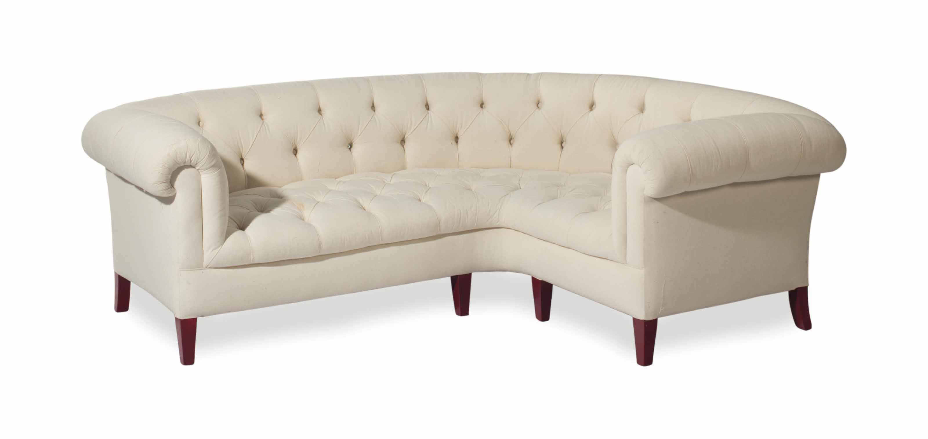 A BUTTON-TUFTED CURVED SOFA COVERED IN WHITE COTTON,