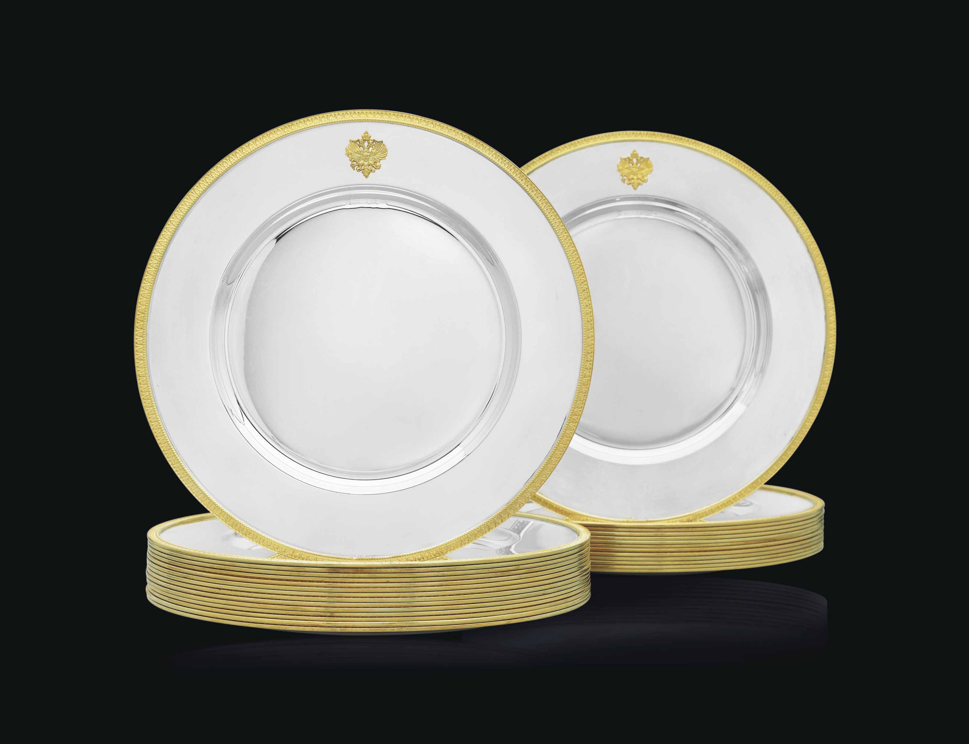 A SET OF TWENTY-EIGHT ITALIAN PARCEL-GILT SILVER DINNER PLATES