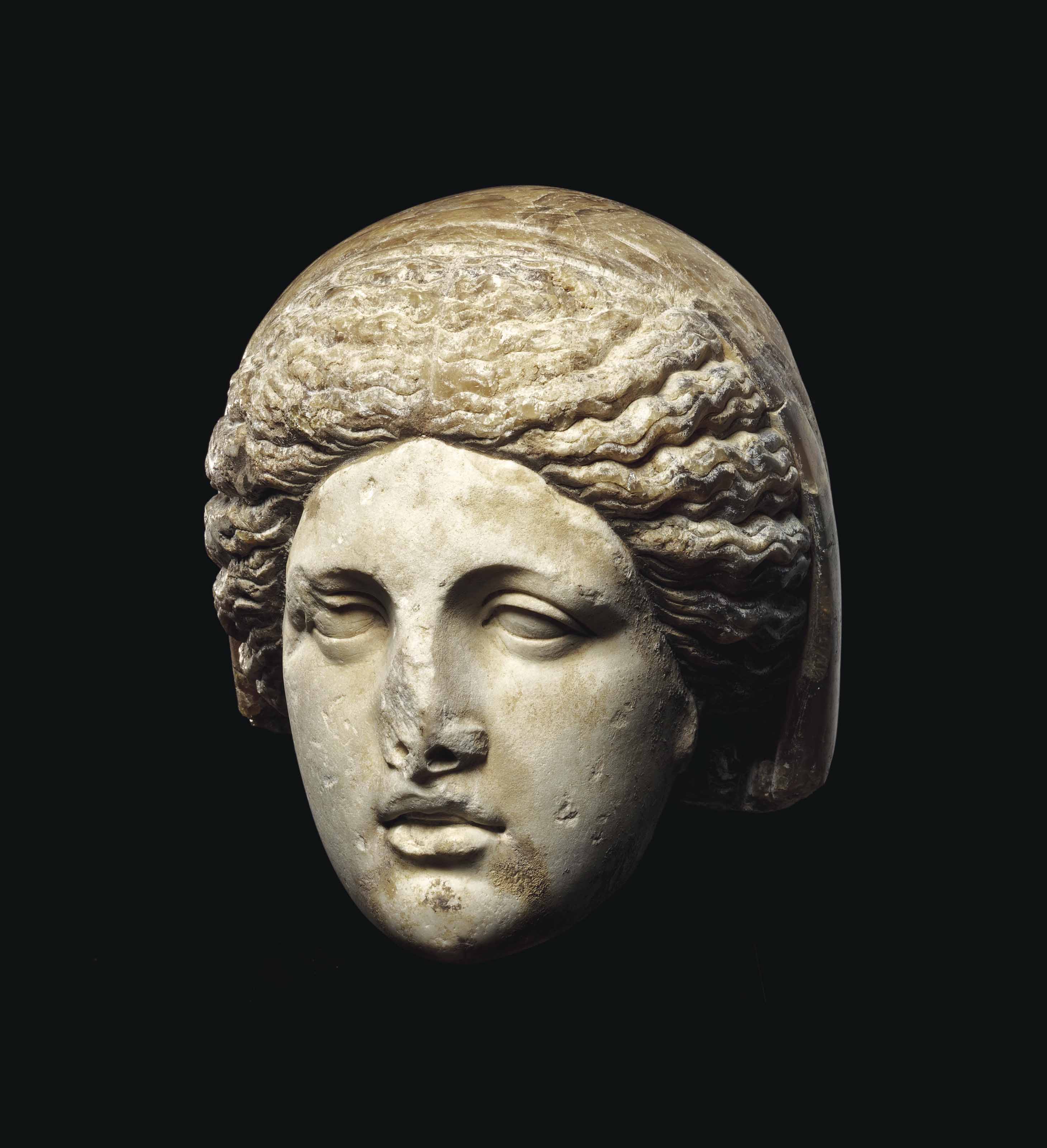 A GREEK MARBLE HEAD OF A GODDESS