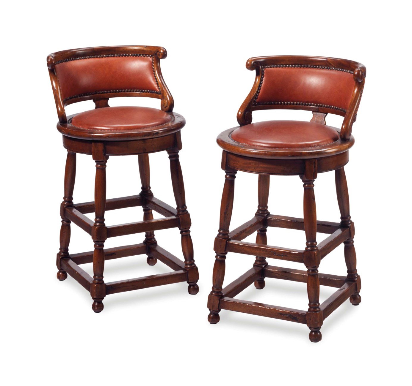 A GROUP OF THREE MEXICAN WALNUT AND LEATHER UPHOLSTERED BAR STOOLS ...