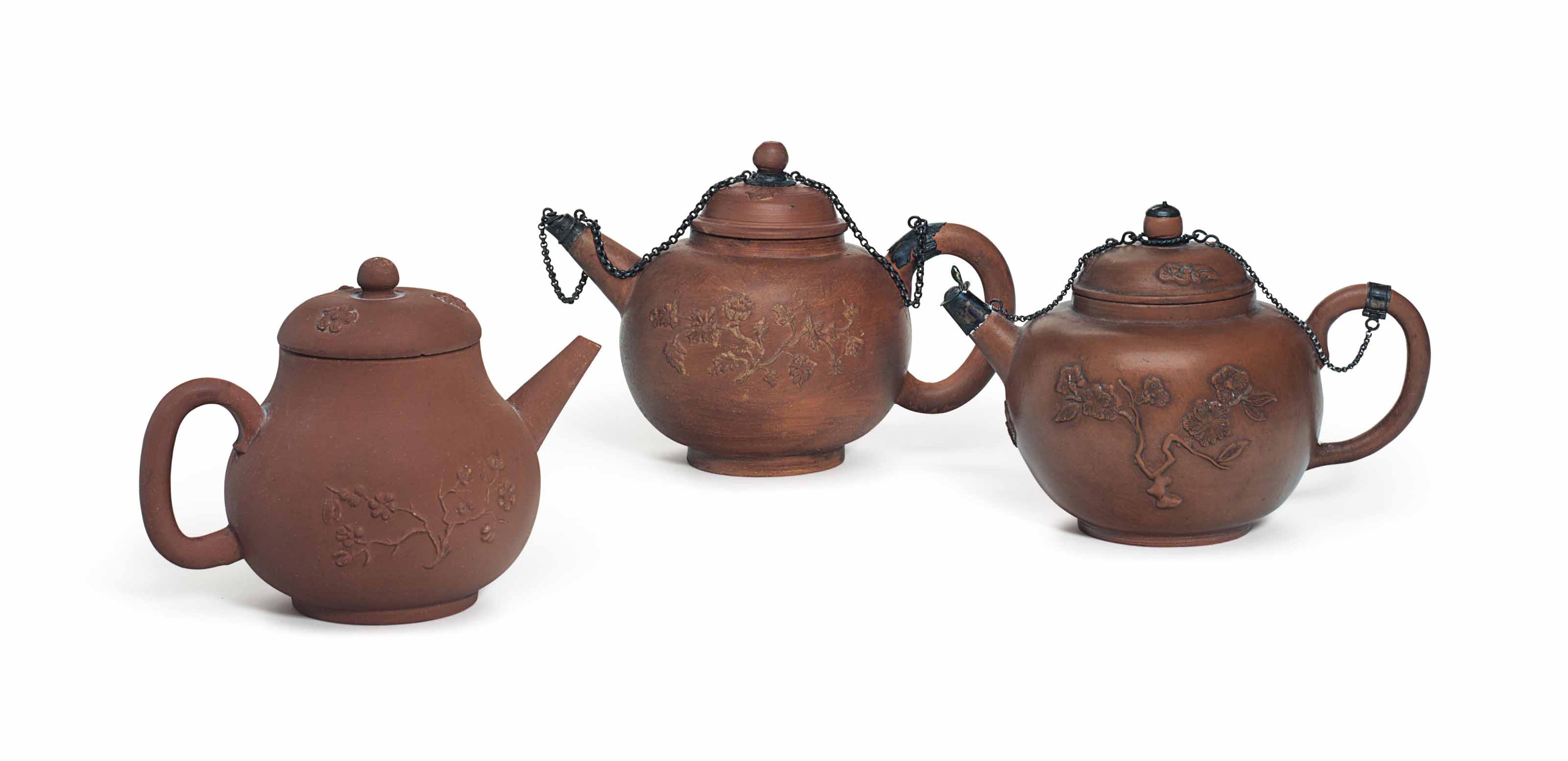 THREE DUTCH REDWARE TEAPOTS AND COVERS