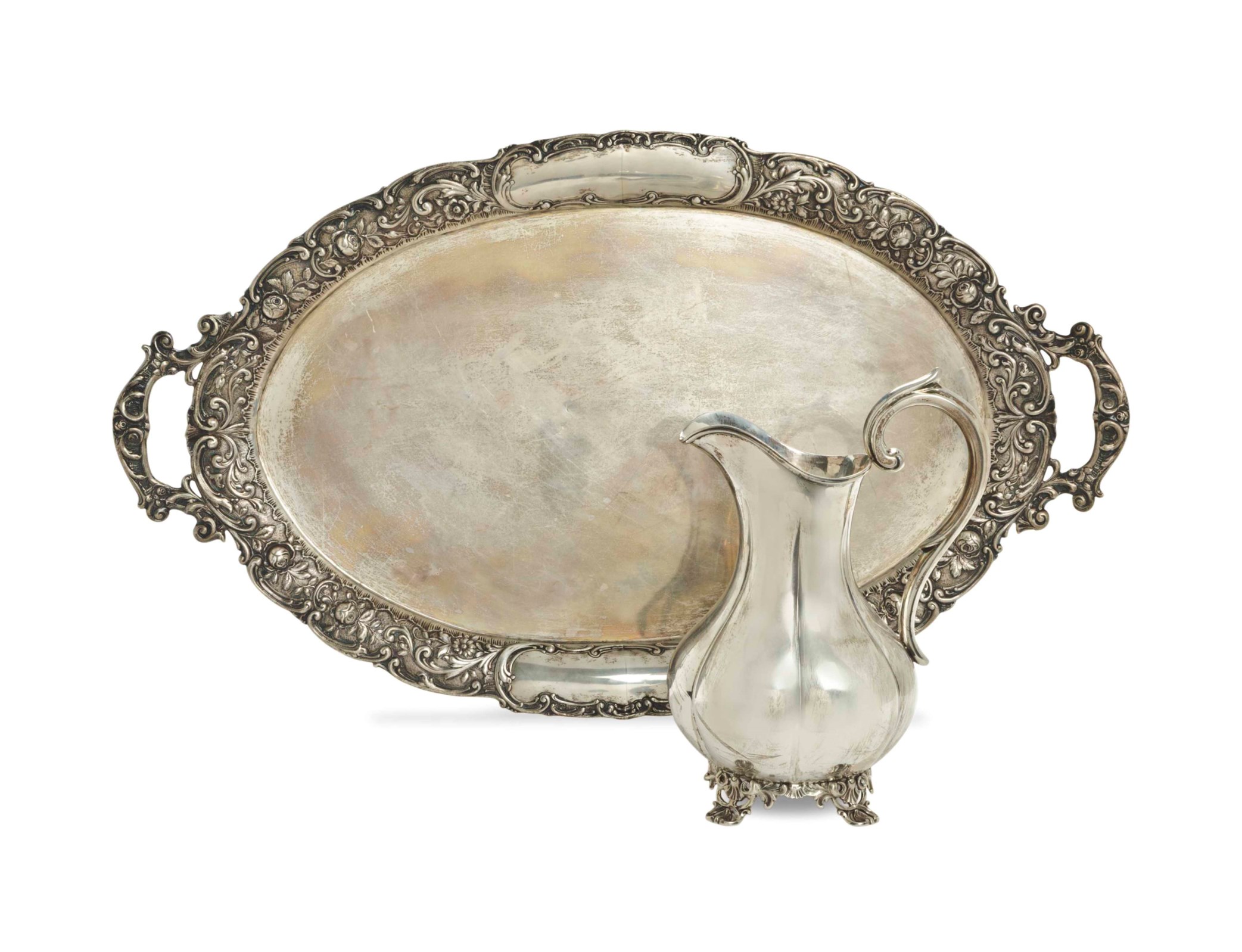 AN EARLY AMERICAN SILVER SHAPED WATER PITCHER, AND AN OVAL TWO HANDLED ...