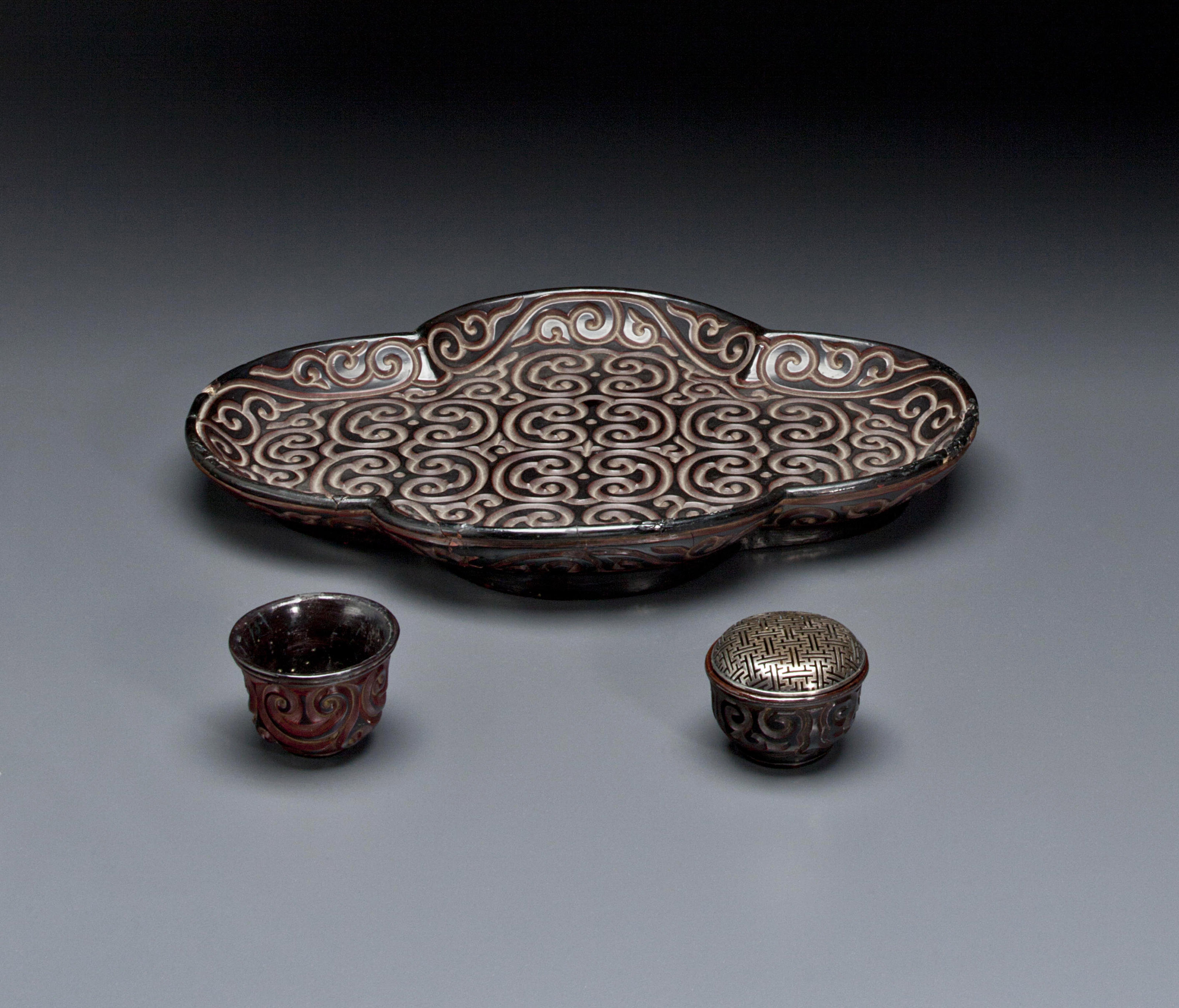 A TIXI LACQUER QUATREFOIL DISH AND TWO TIXI LACQUER CUPS, MING-QING ...