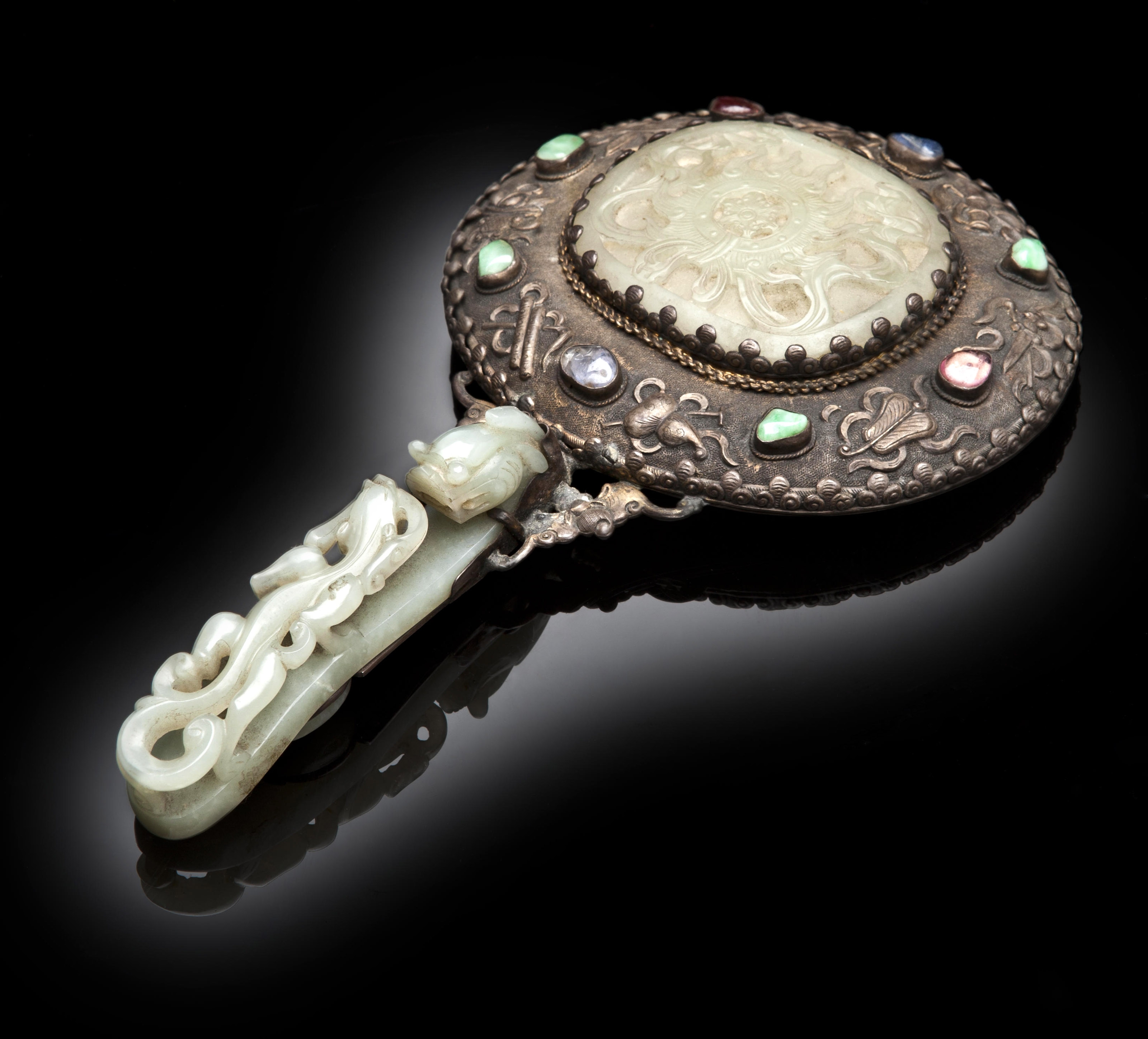 A GREENISH-WHITE JADE-MOUNTED AND EMBELLISHED SILVER HAND MIRROR, LATE ...