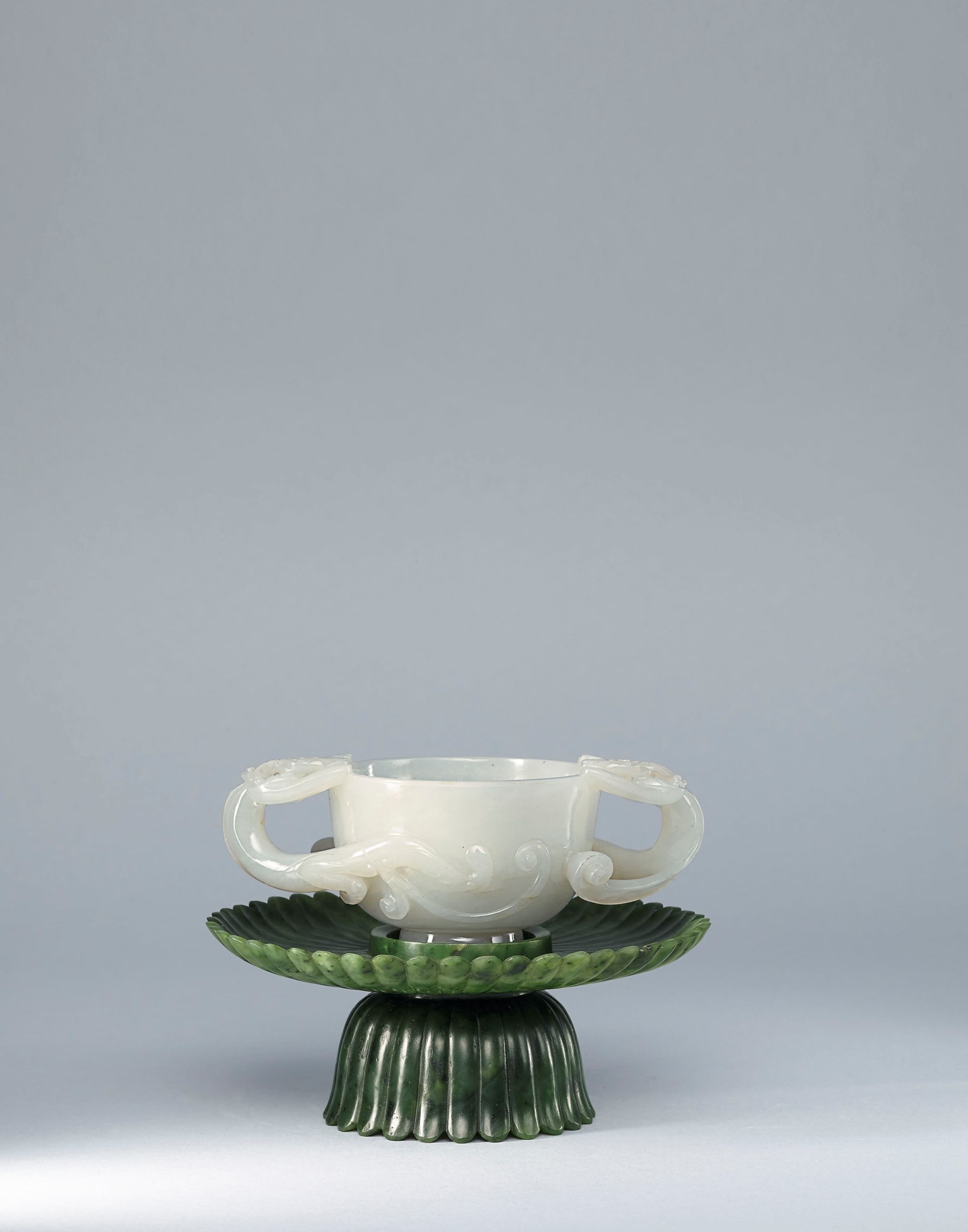 A WHITE JADE 'CHILONG' CUP AND A SPINACH JADE CUP STAND , THE CUP MING ...