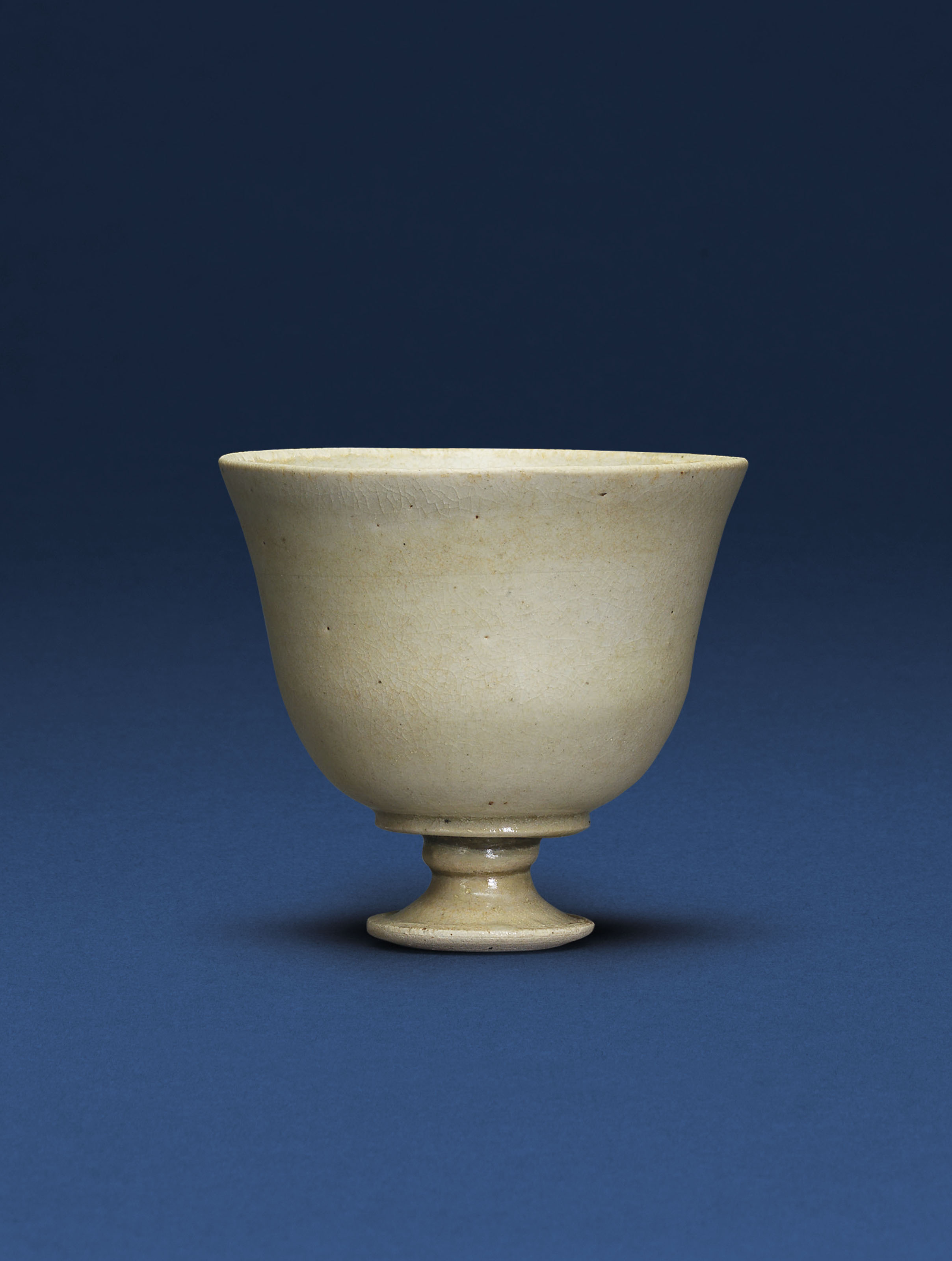 A WHITE-GLAZED STEM CUP