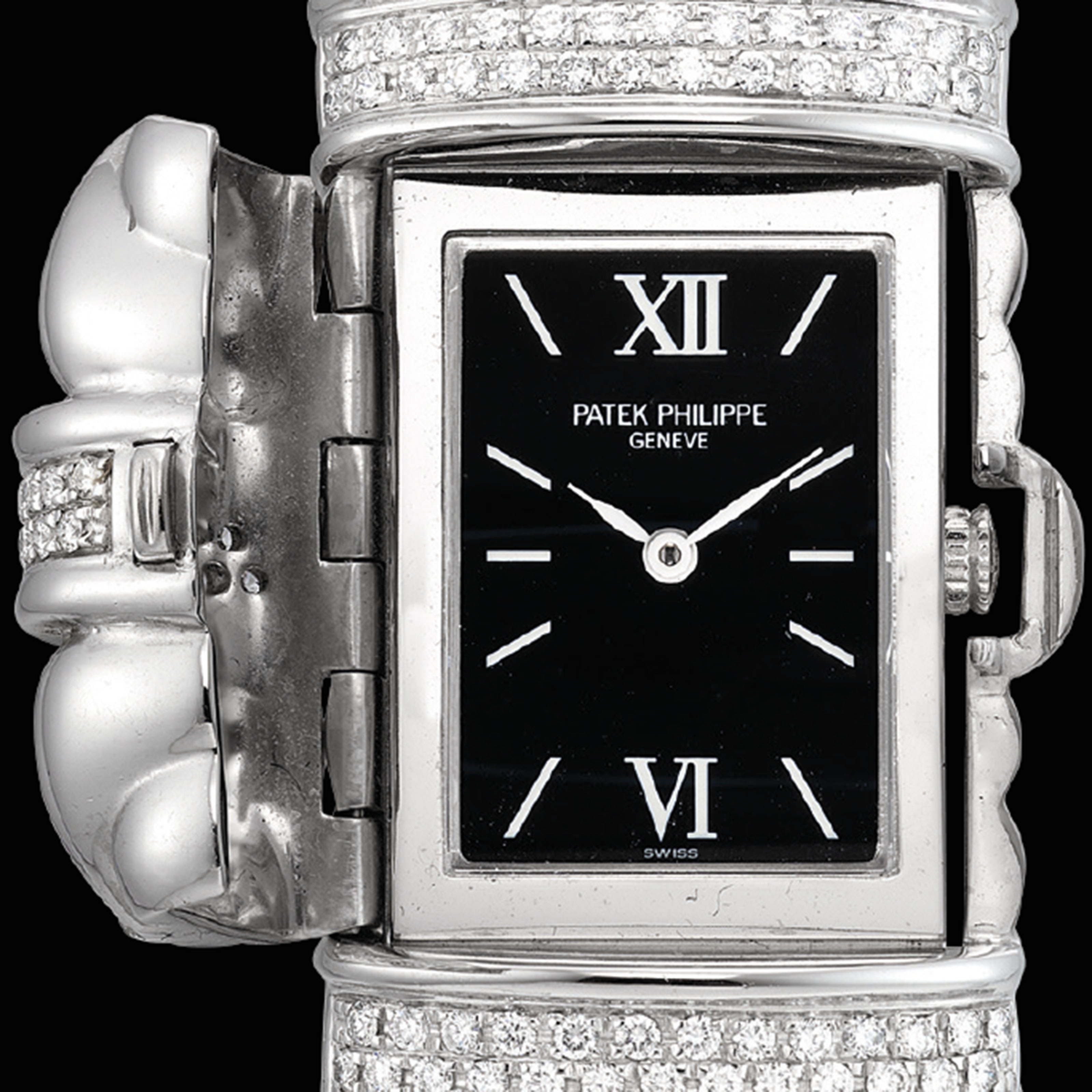 PATEK PHILIPPE. A LADY’S ELEGANT AND UNUSUAL 18K WHITE GOLD AND DIAMOND ...