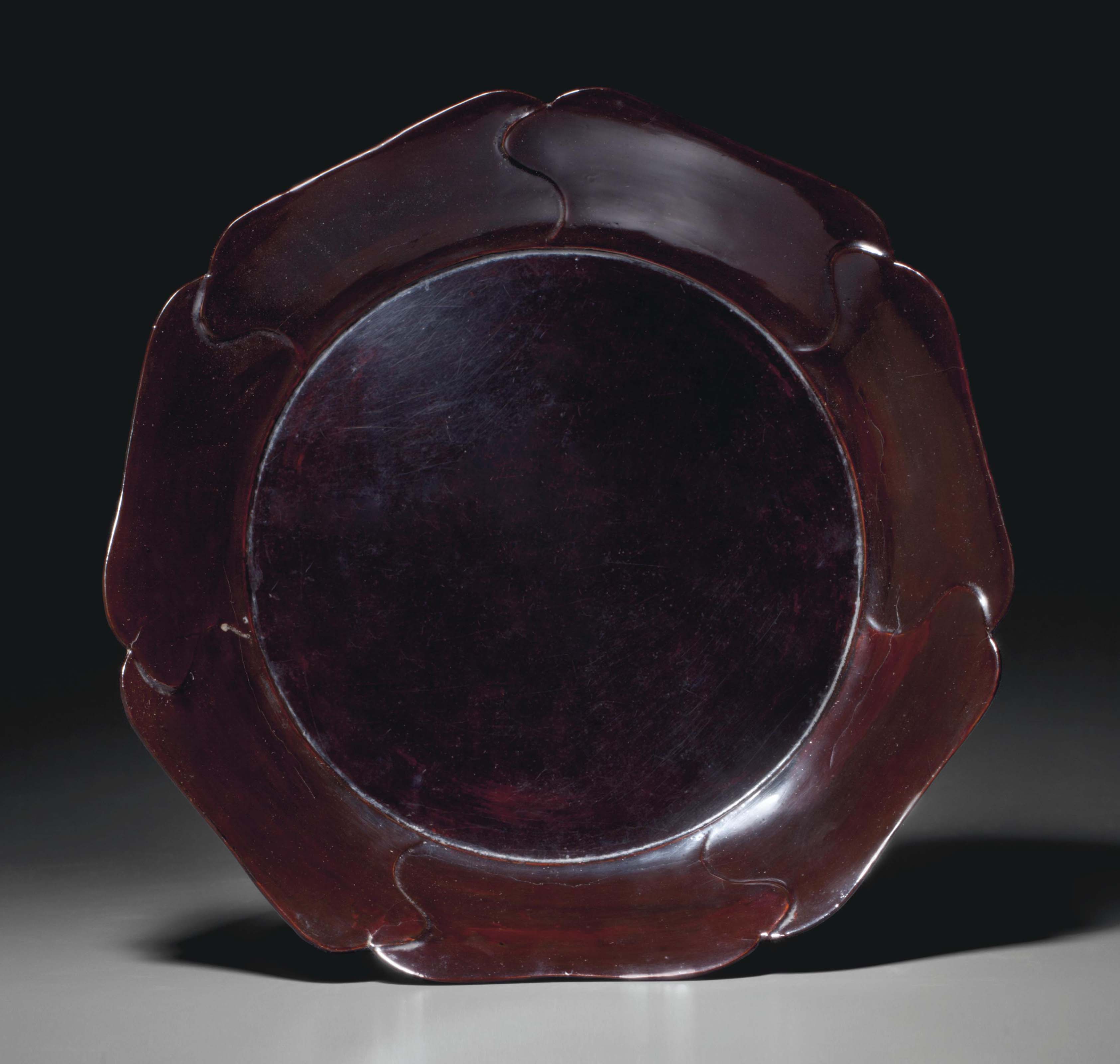 A LARGE BLACK LACQUER MALLOW-FORM DISH