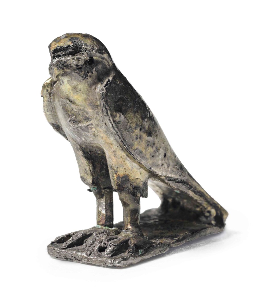 AN EGYPTIAN GILT SILVER FALCON